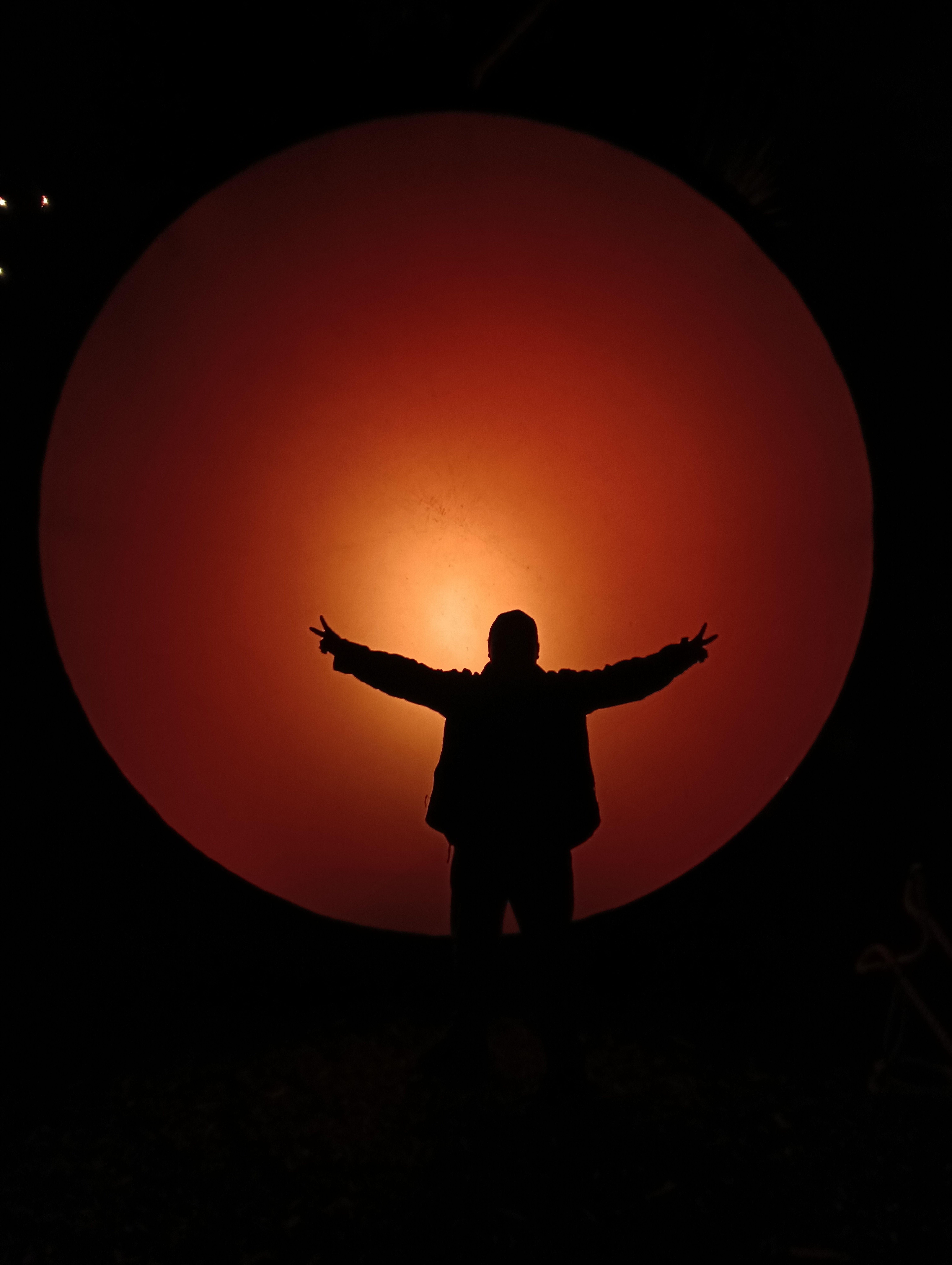 Silhouette Against Glowing Amber Circle · Free Stock Photo