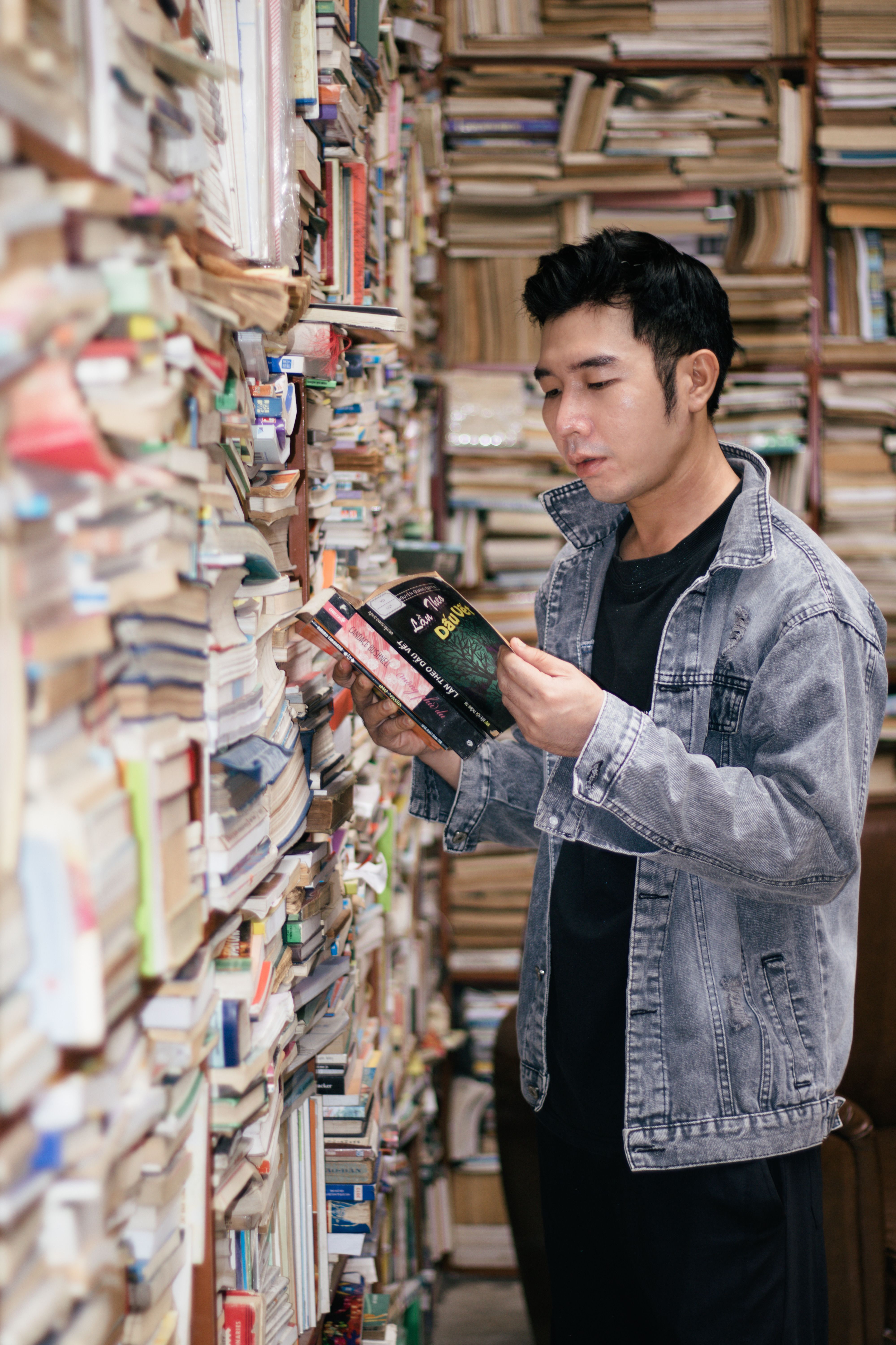 Young Asian Man Reading in Ho Chi Minh City Library · Free Stock Photo