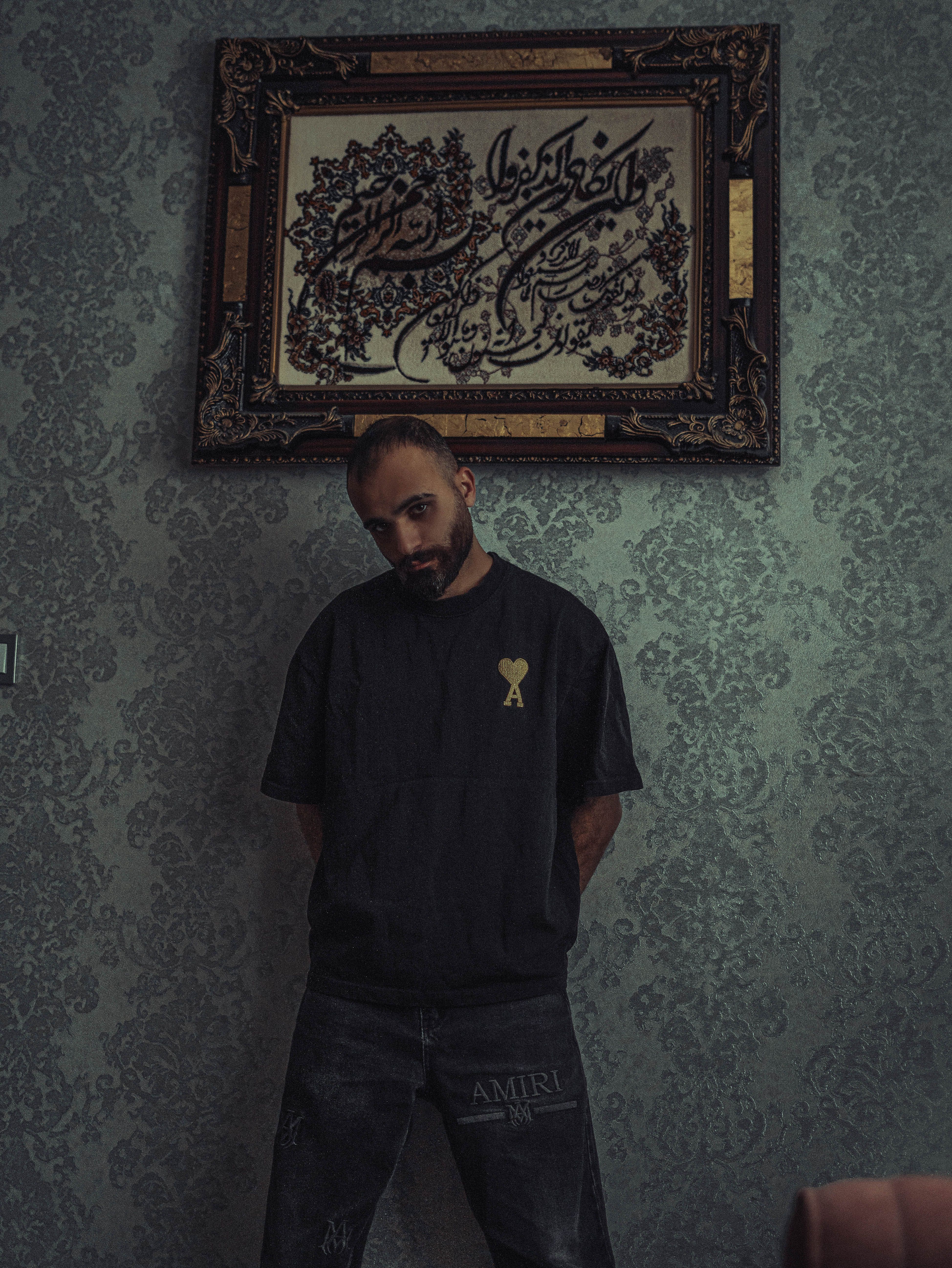 Moody Portrait Indoors with Calligraphy Art · Free Stock Photo
