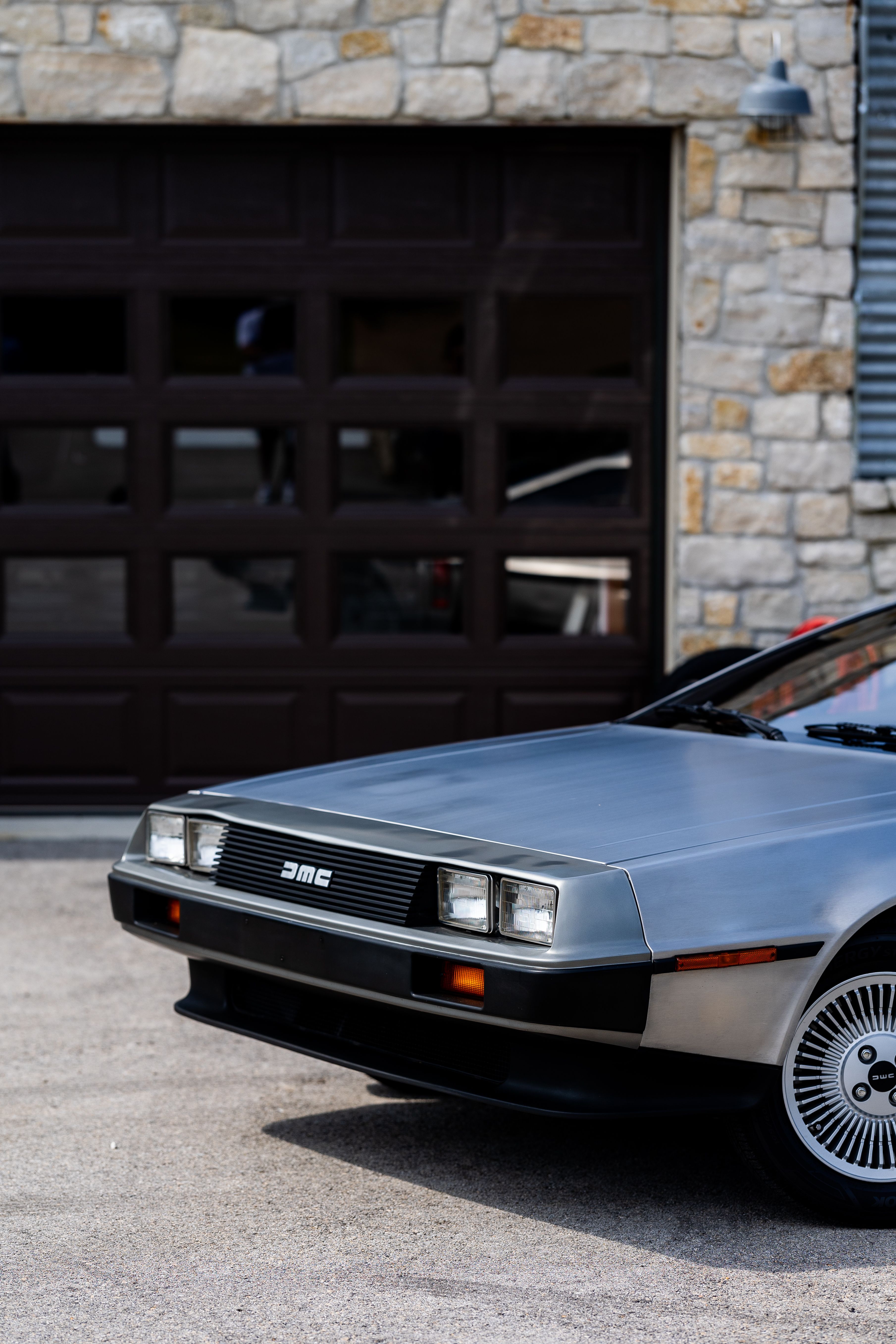 Classic DeLorean DMC-12 in front of garage · Free Stock Photo
