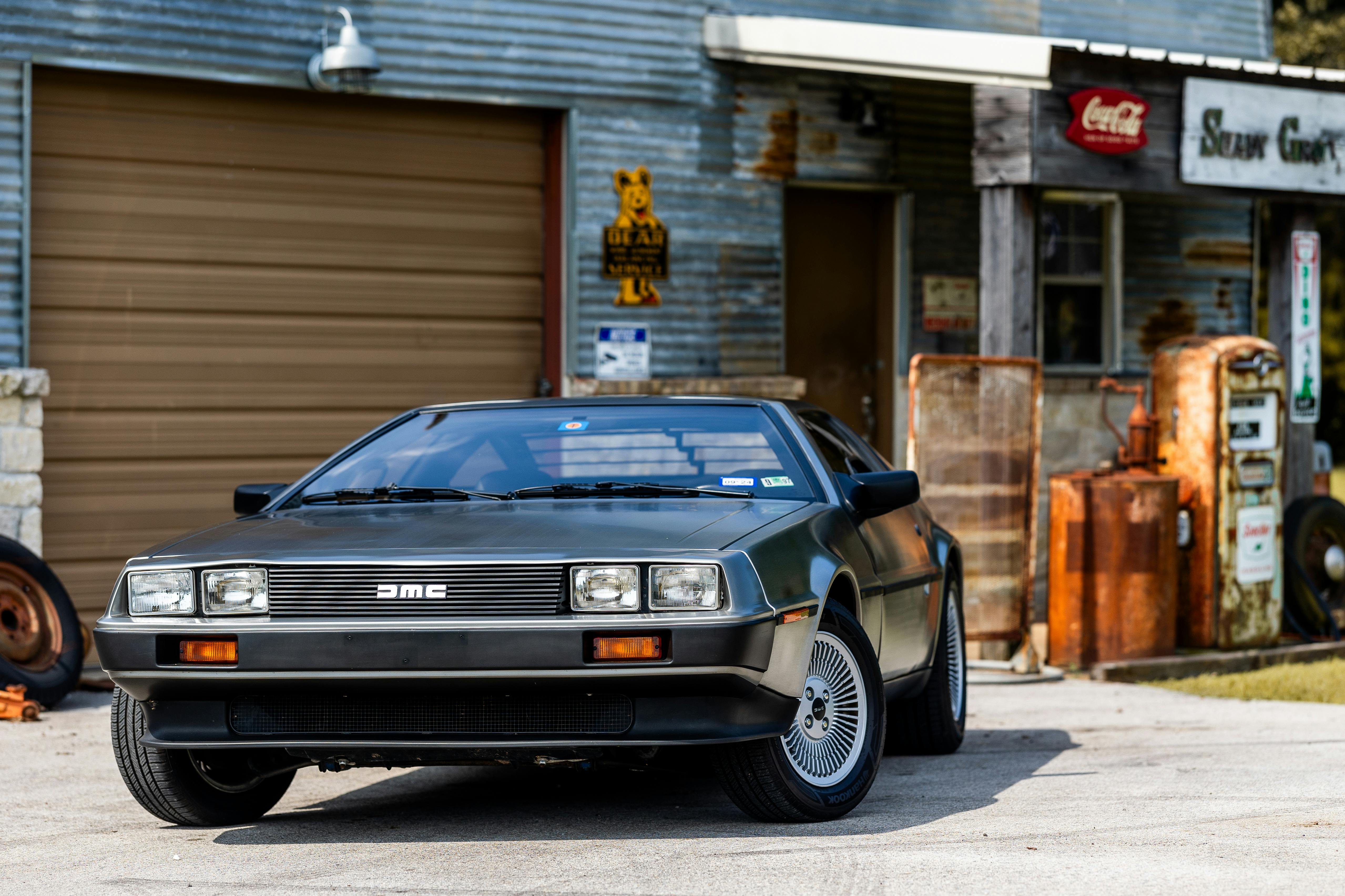 Iconic DeLorean Car at Retro Gas Station · Free Stock Photo
