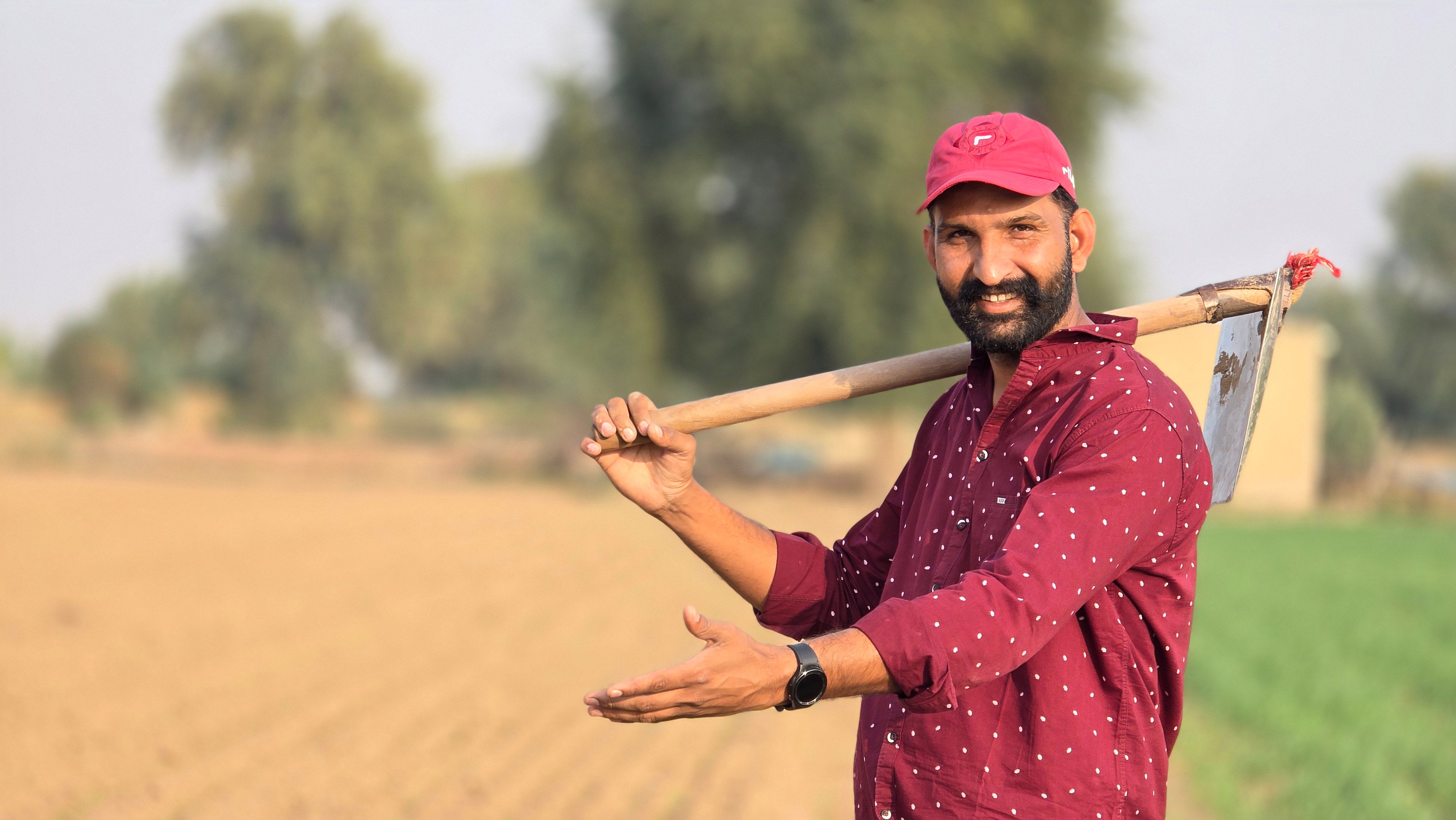 Indian Farmer in Field with Hoe on Sunny Day · Free Stock Photo