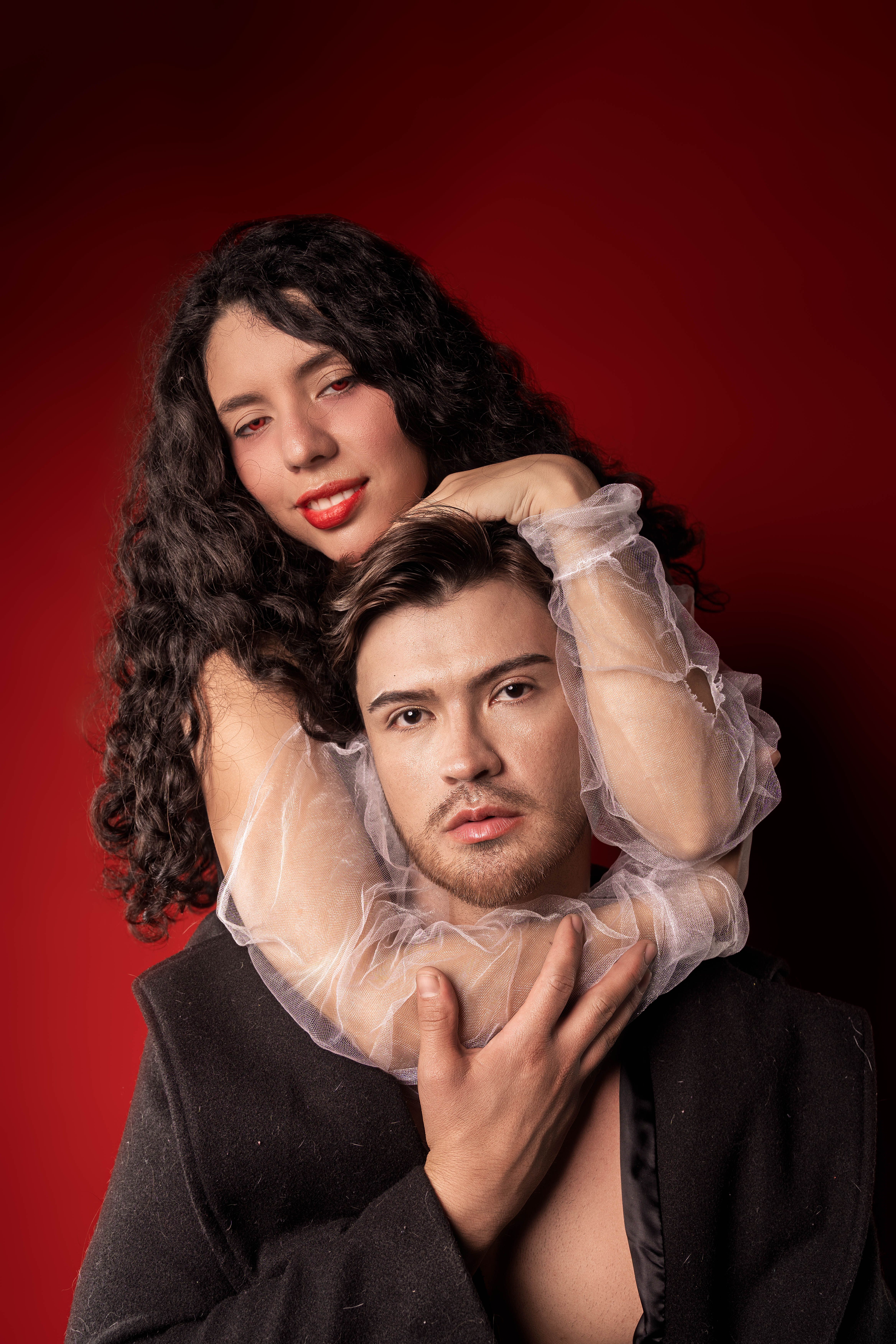 Elegant Couple Posing Against Red Background · Free Stock Photo