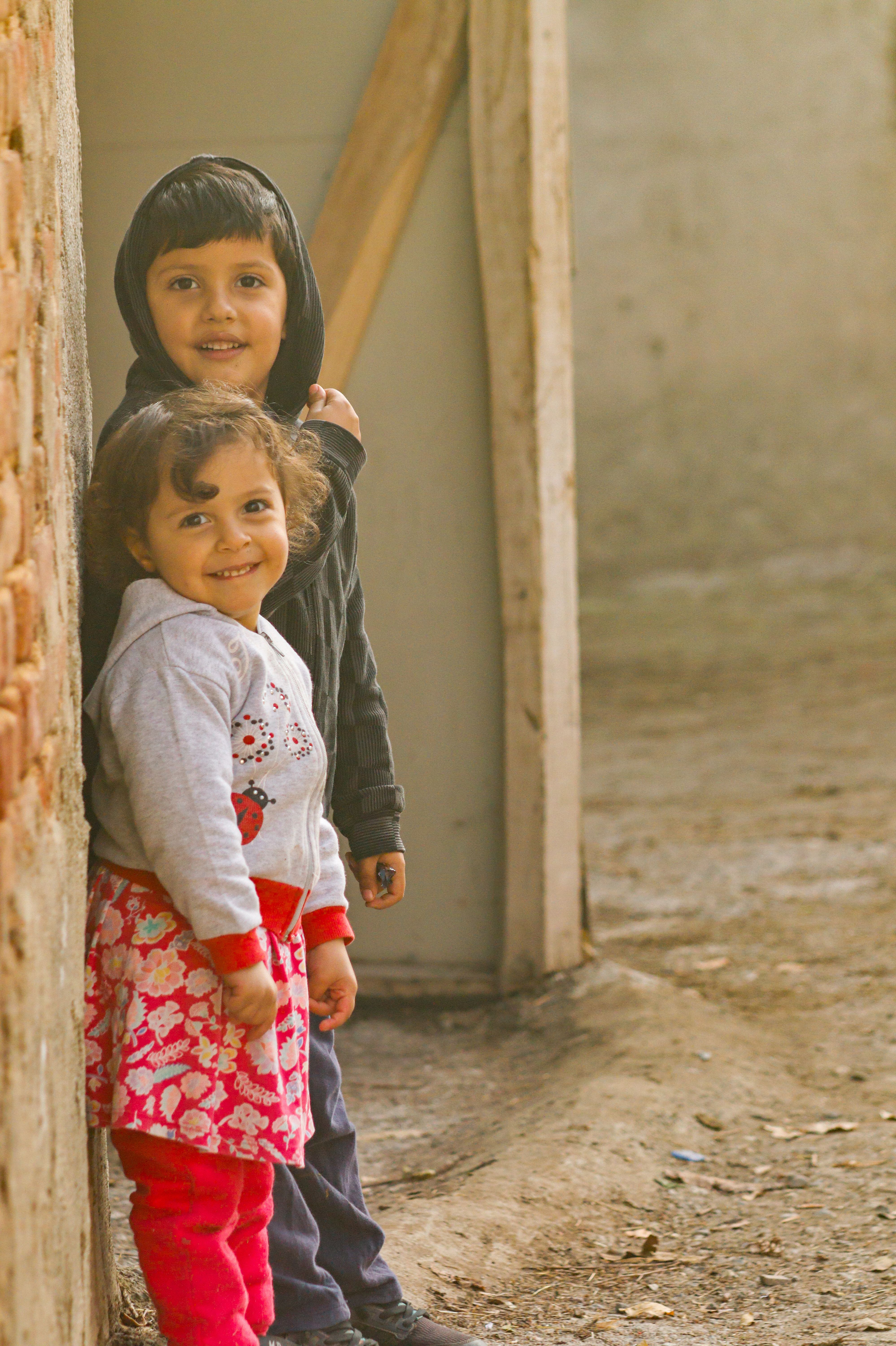 Two children smiling in an outdoor setting · Free Stock Photo