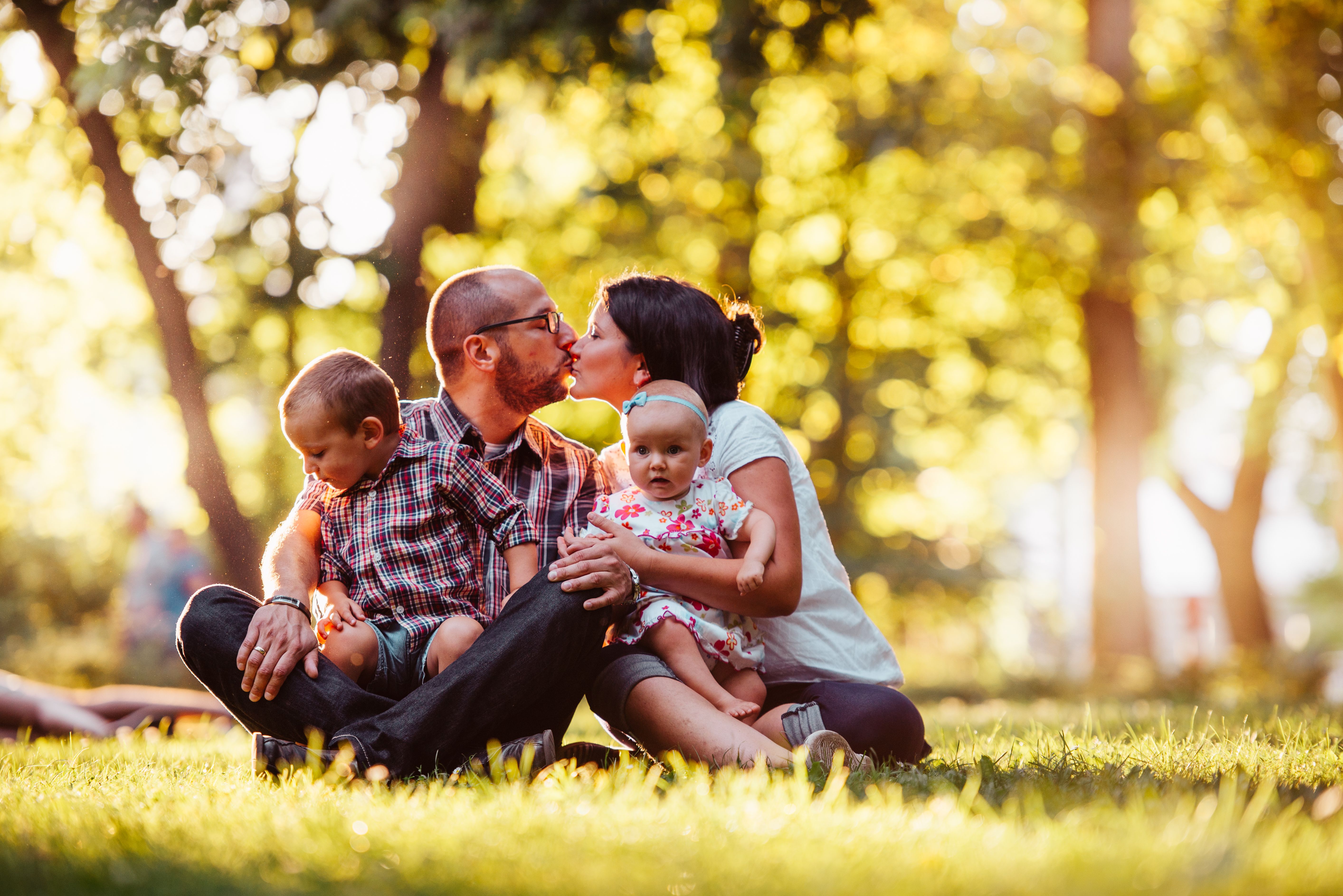 Happy Family Enjoying Sunny Day in a Park · Free Stock Photo