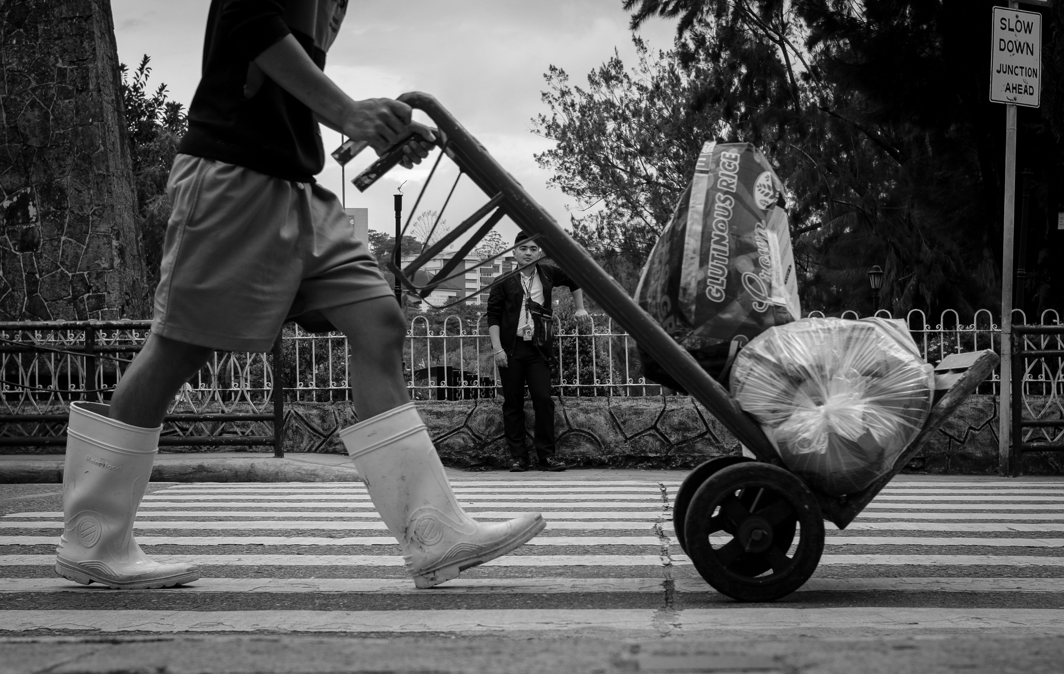 Street Worker Pushing Cart in Urban Setting · Free Stock Photo