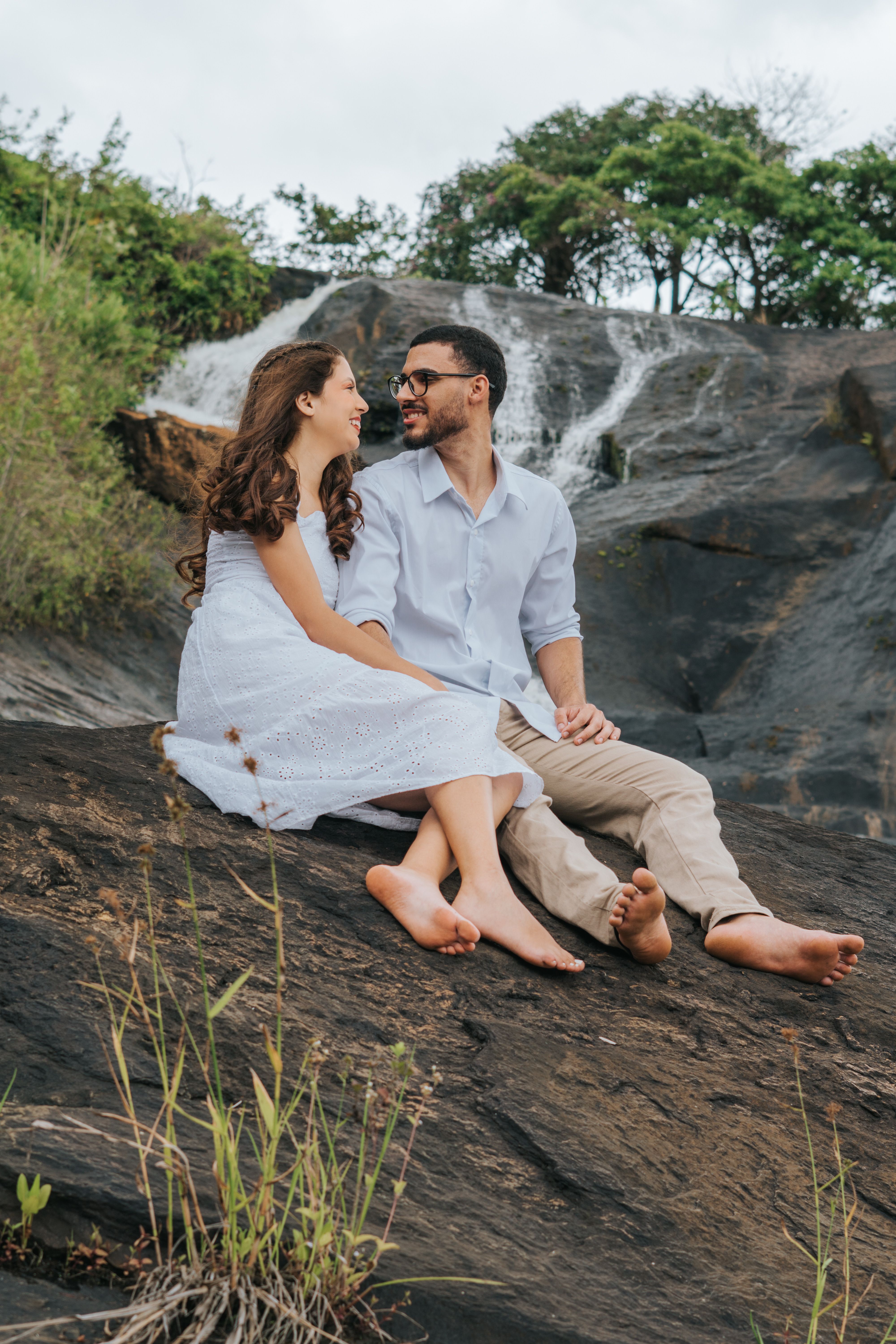 Romantic Couple Relaxing by a Waterfall · Free Stock Photo