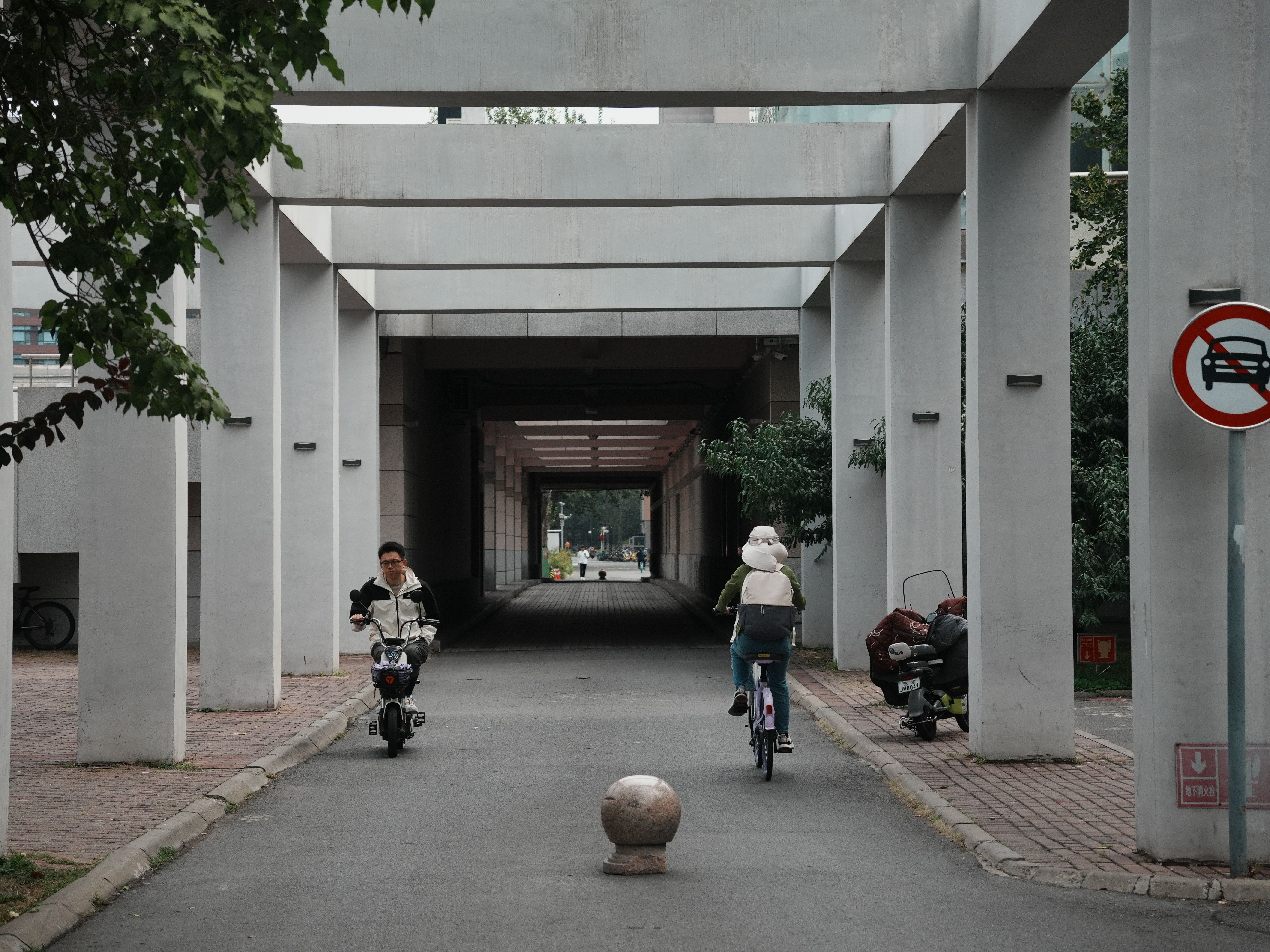 Urban Passageway with Cyclists and Modern Architecture · Free Stock Photo