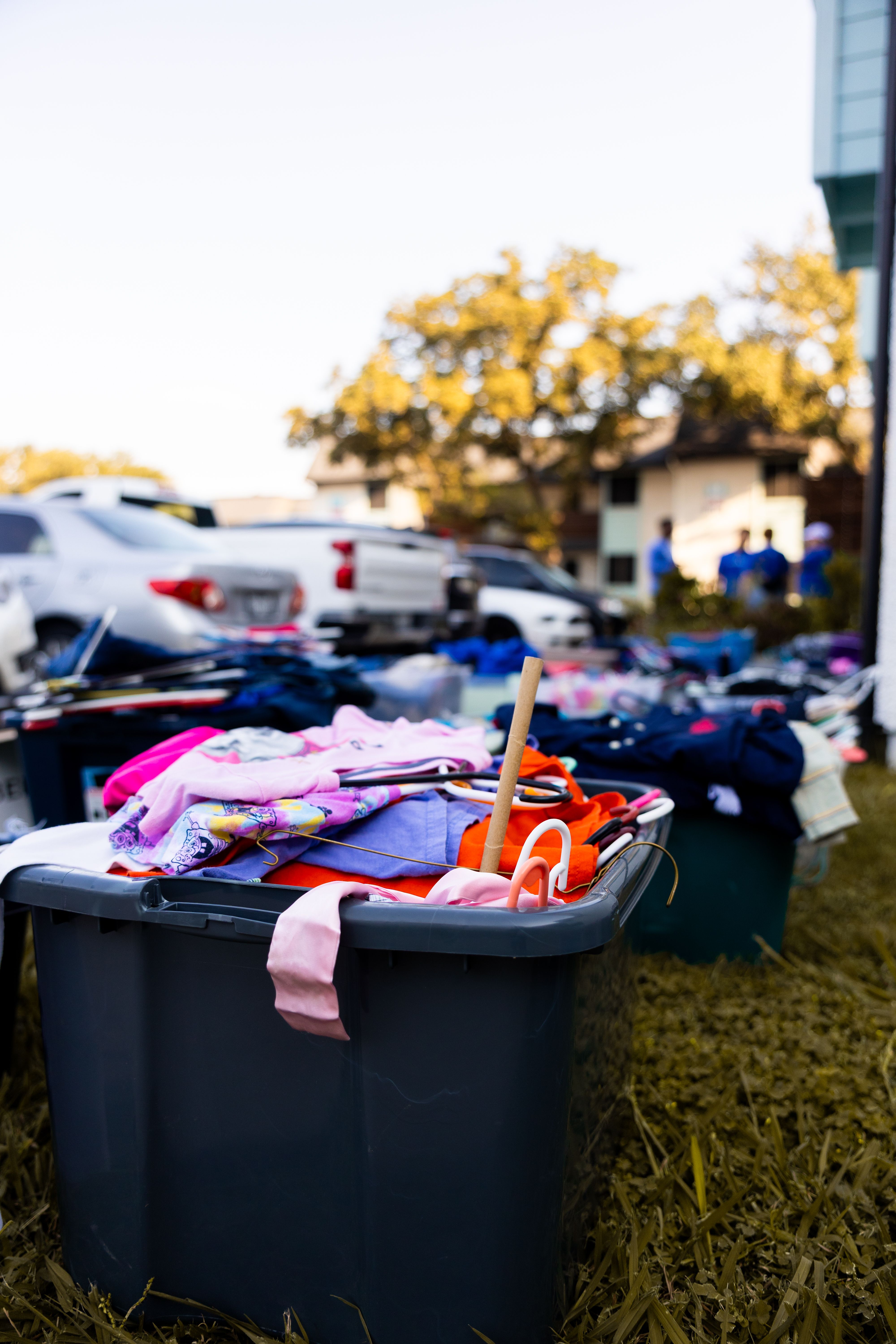 Outdoor Yard Sale with Colorful Clothing Bins · Free Stock Photo