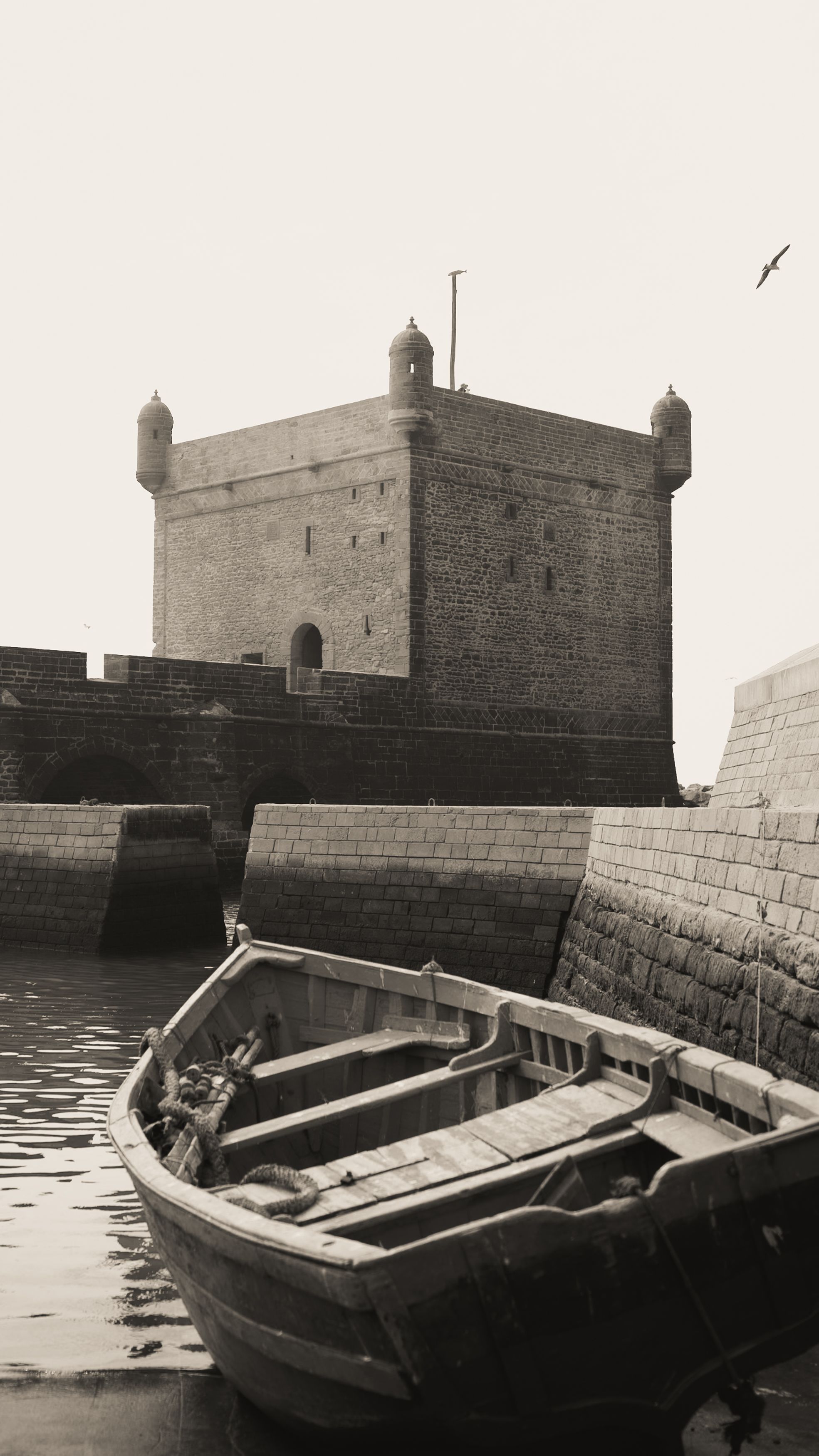Historic Fortress and Boat in Monochrome · Free Stock Photo