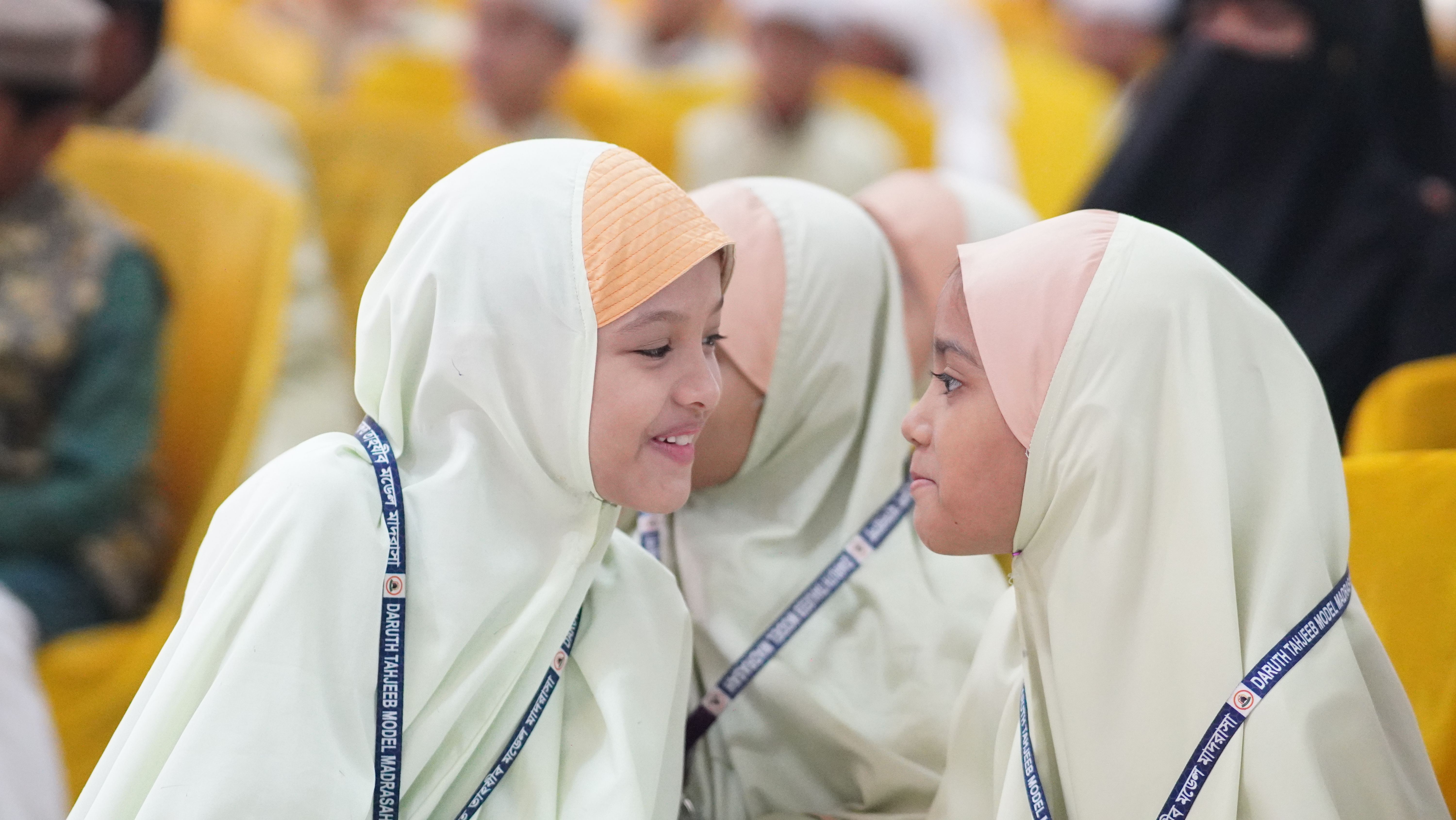 Young Girls Engaging in Conversation at School Event · Free Stock Photo