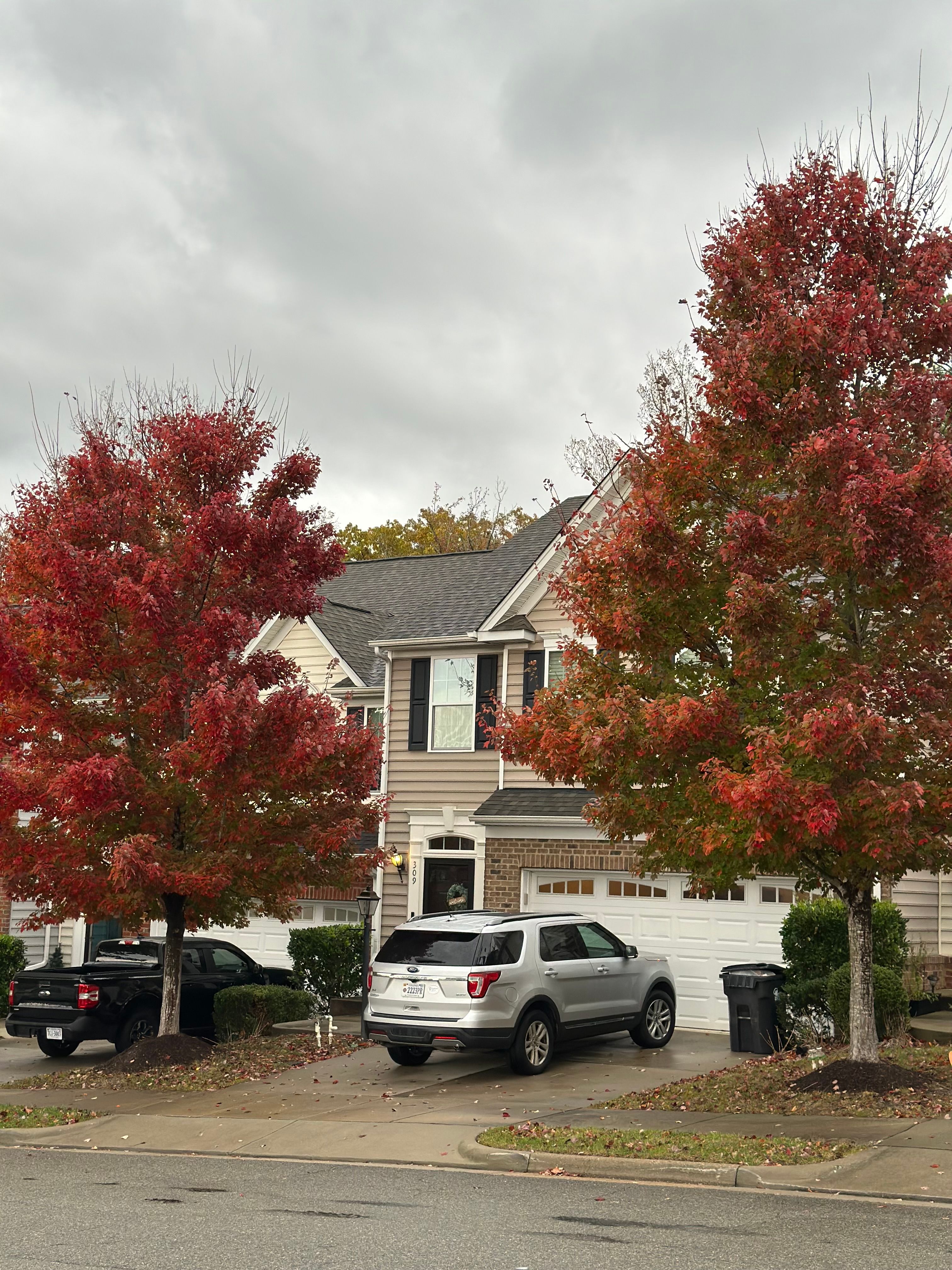 Suburban House with Autumn Foliage and Parked Cars · Free Stock Photo