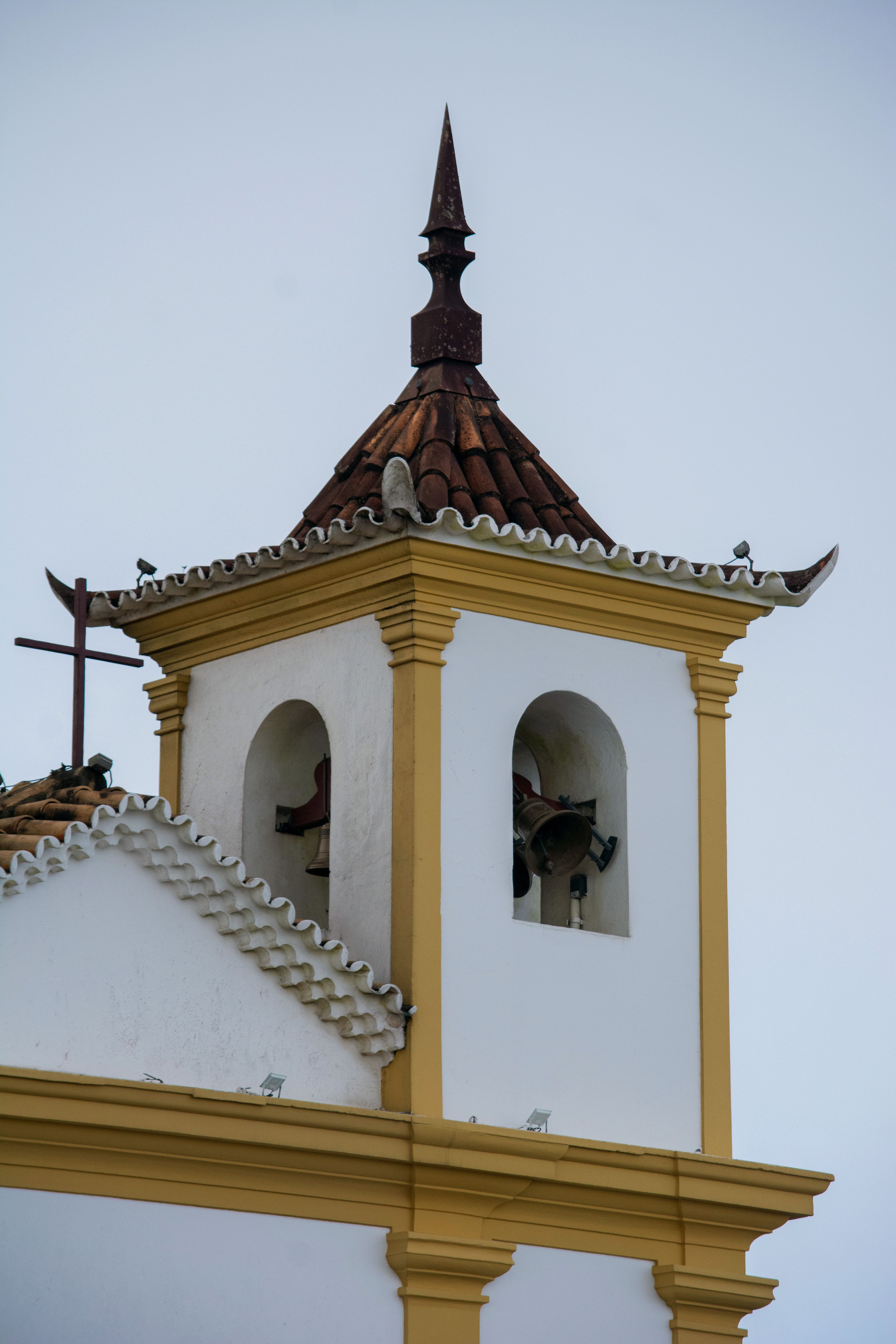 Historic Church Tower with Bells and Spire · Free Stock Photo