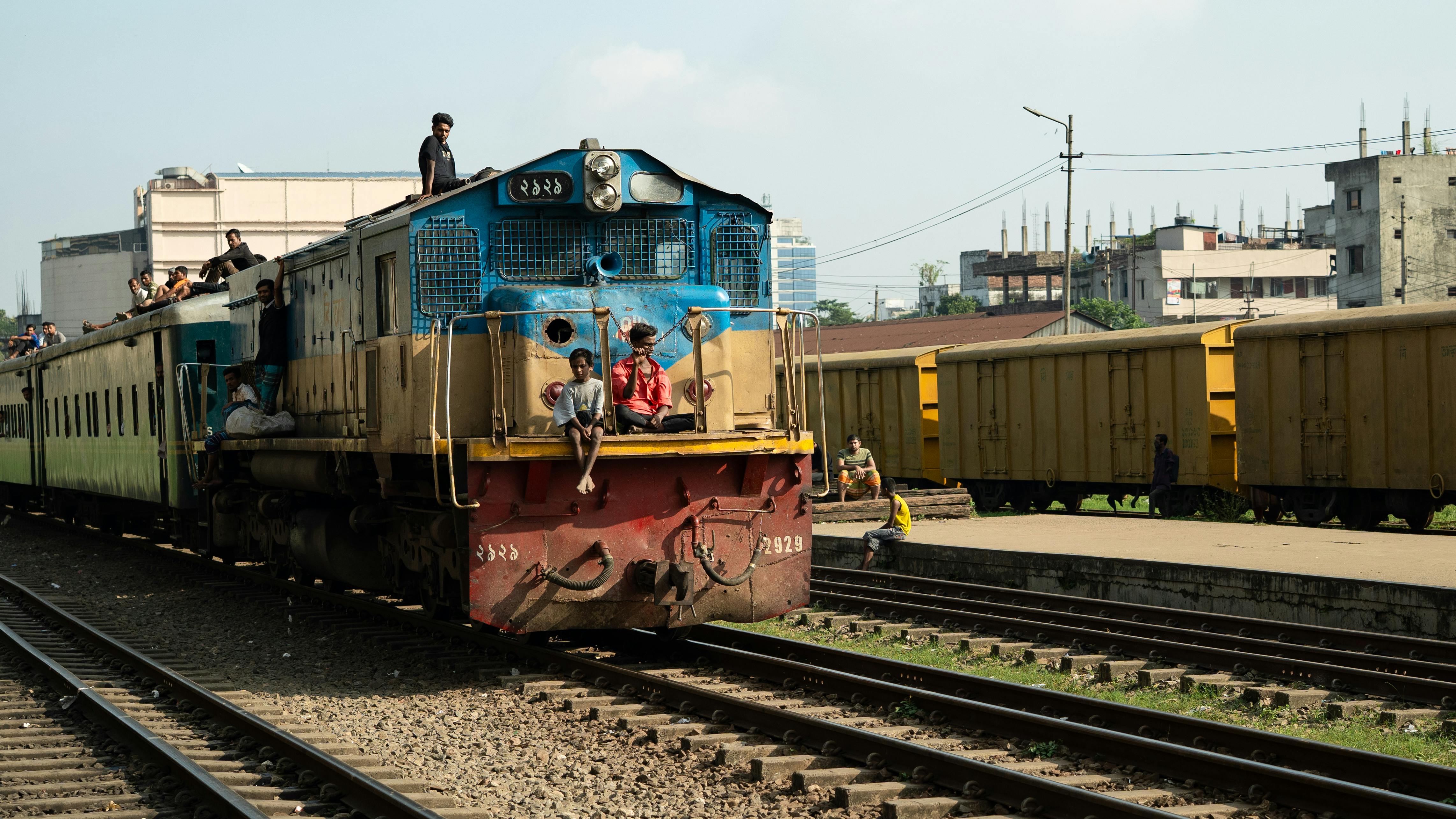 Urban Vibes: Passengers on a Dhaka Train · Free Stock Photo