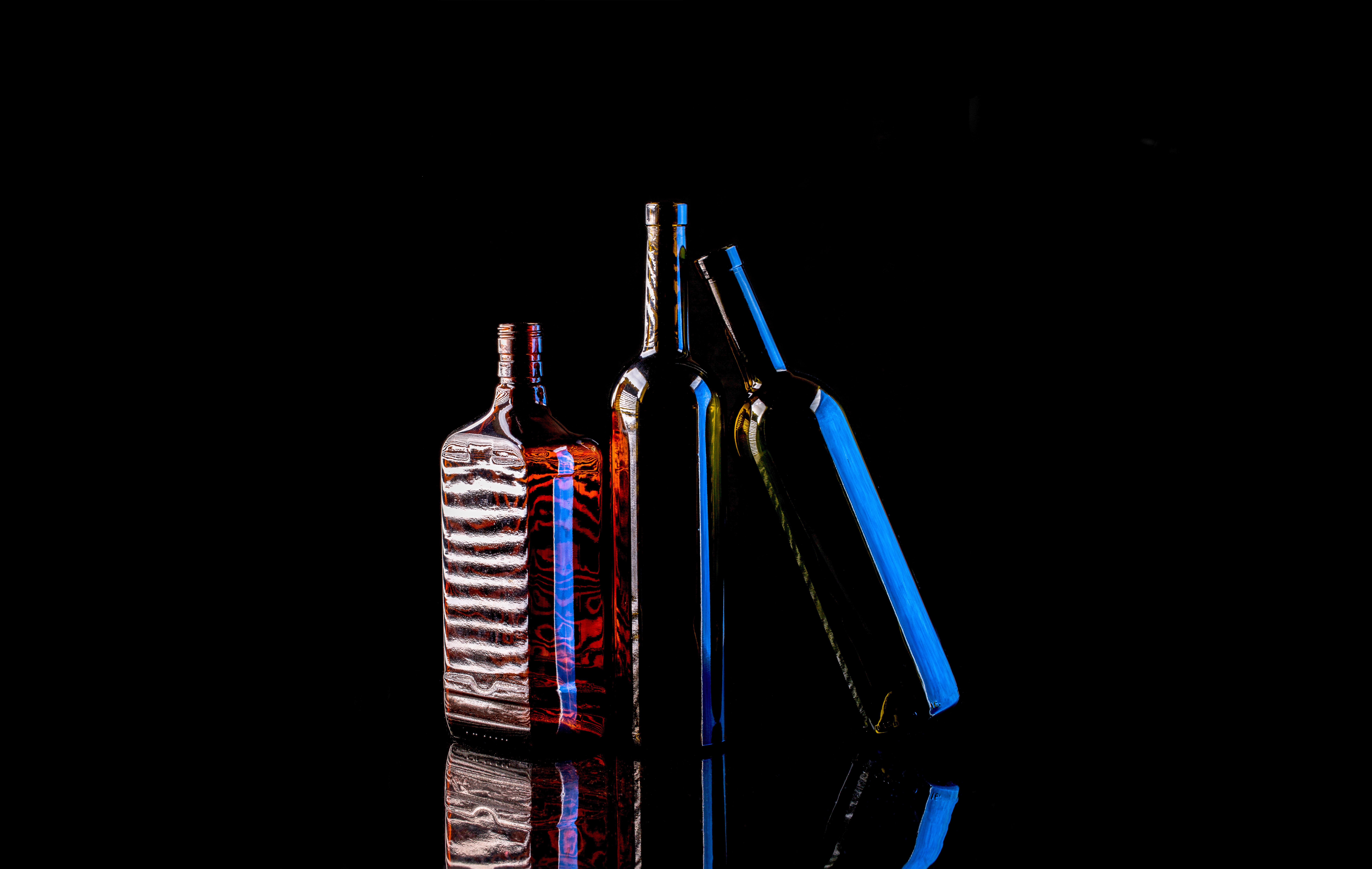Artistic Photo of Backlit Glass Bottles on Reflective Surface · Free ...