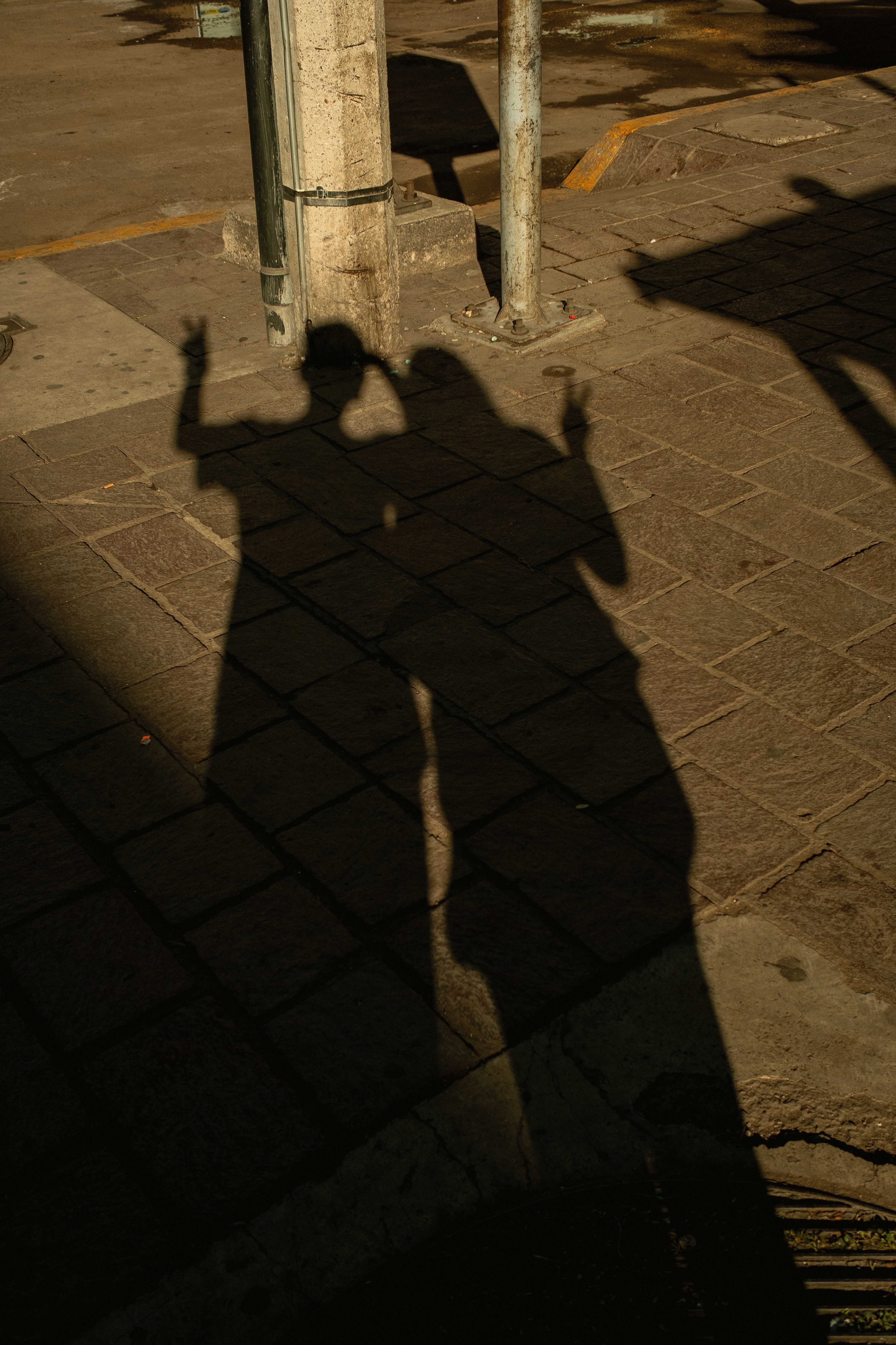 Silhouetted Shadows on Urban Pavement · Free Stock Photo