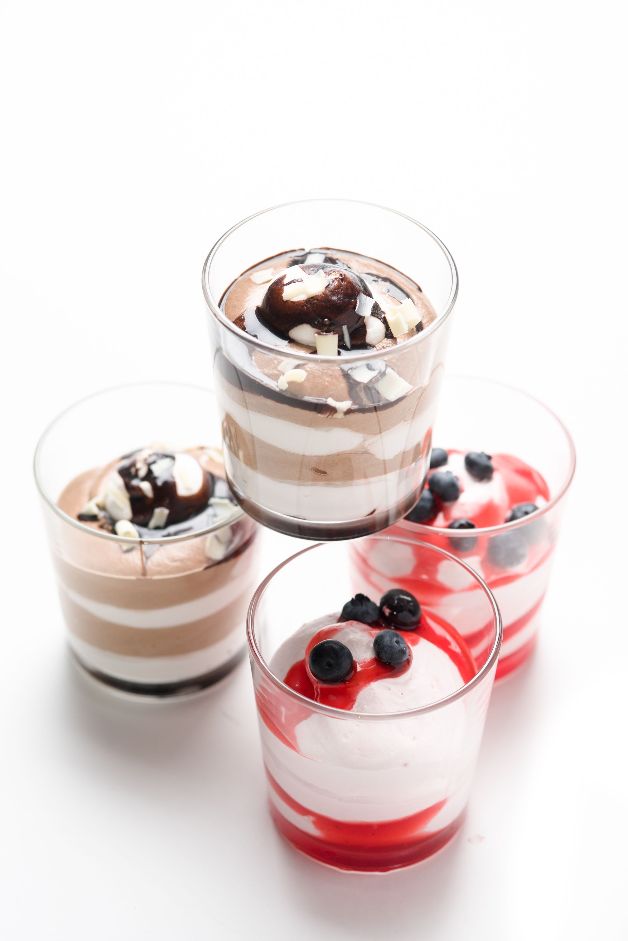 Delicious Layered Dessert Cups with Mixed Berry Toppings · Free Stock Photo