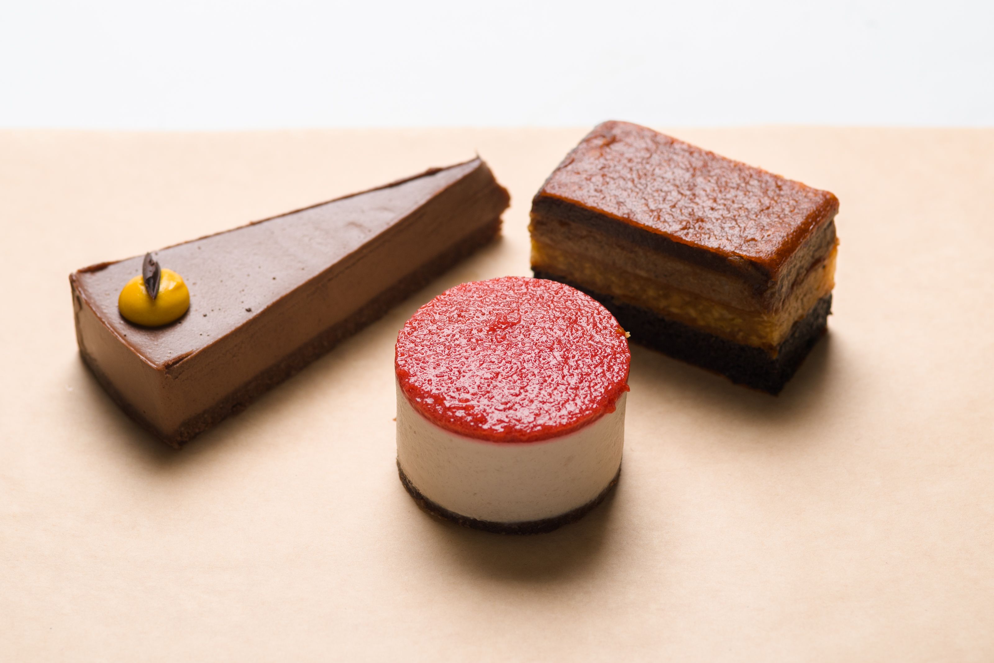 Assorted Gourmet Desserts Flat Lay on Parchment · Free Stock Photo