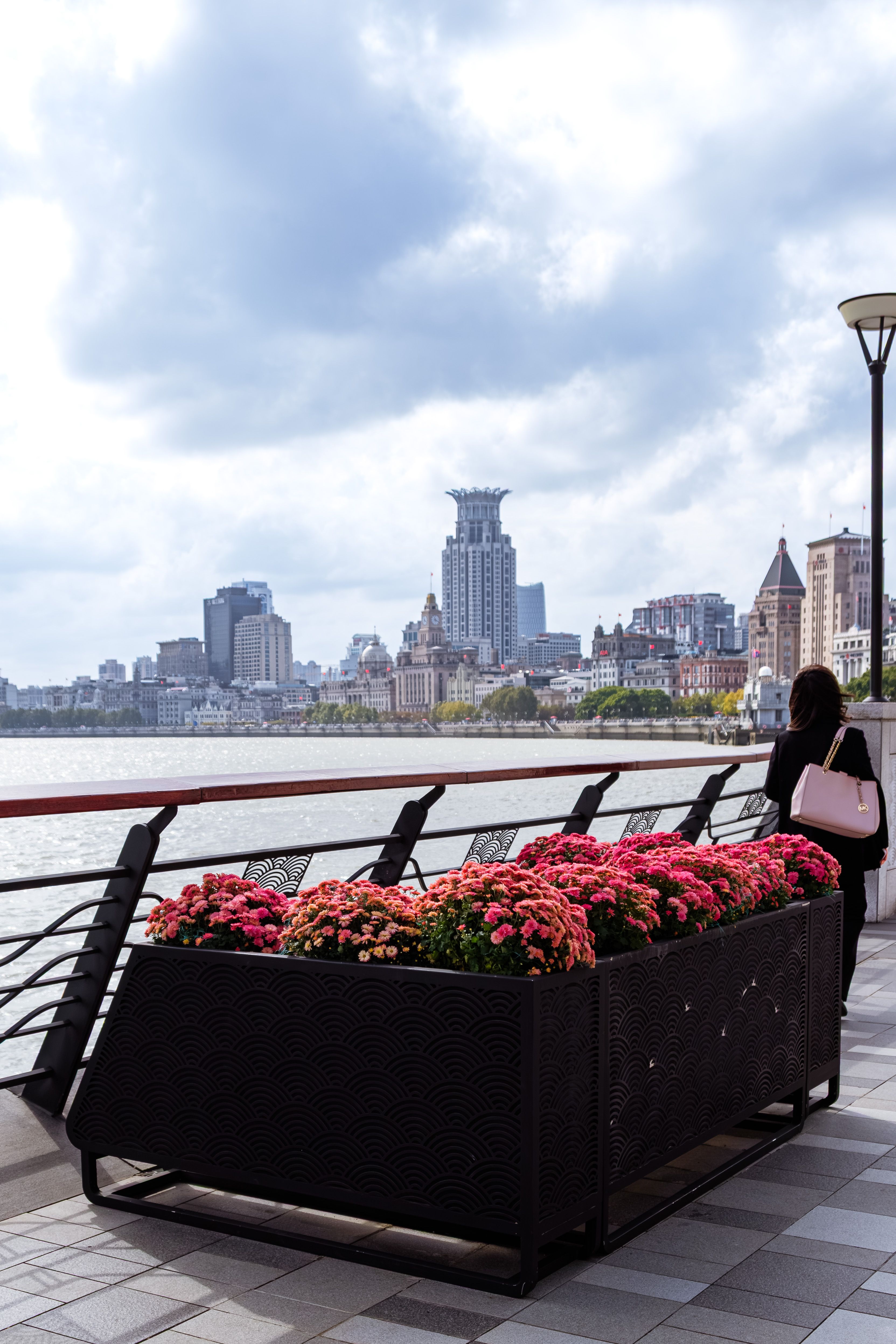 Scenic Riverfront Walkway with City Skyline · Free Stock Photo