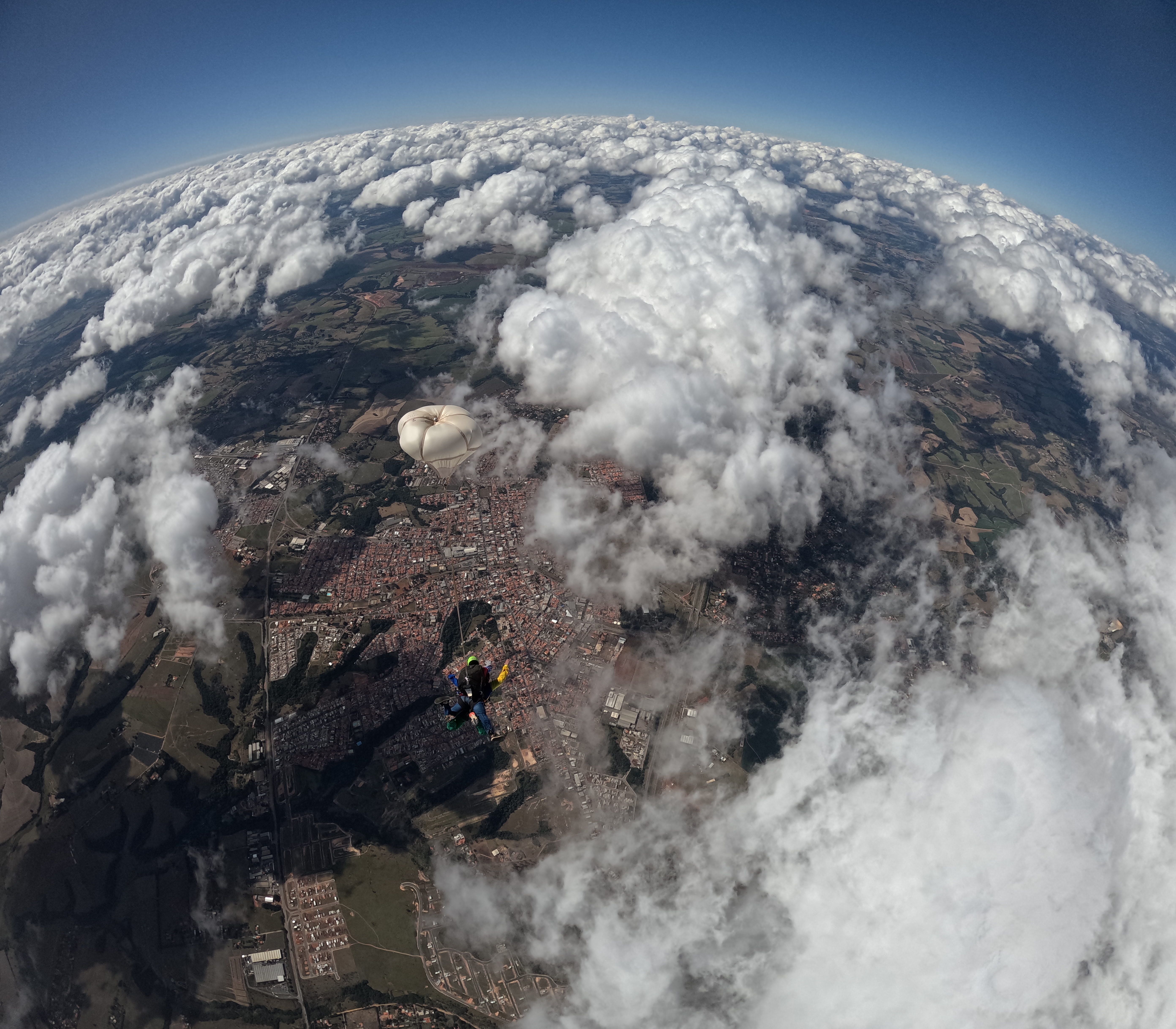 Aerial View of Skydiver Above Cityscape · Free Stock Photo