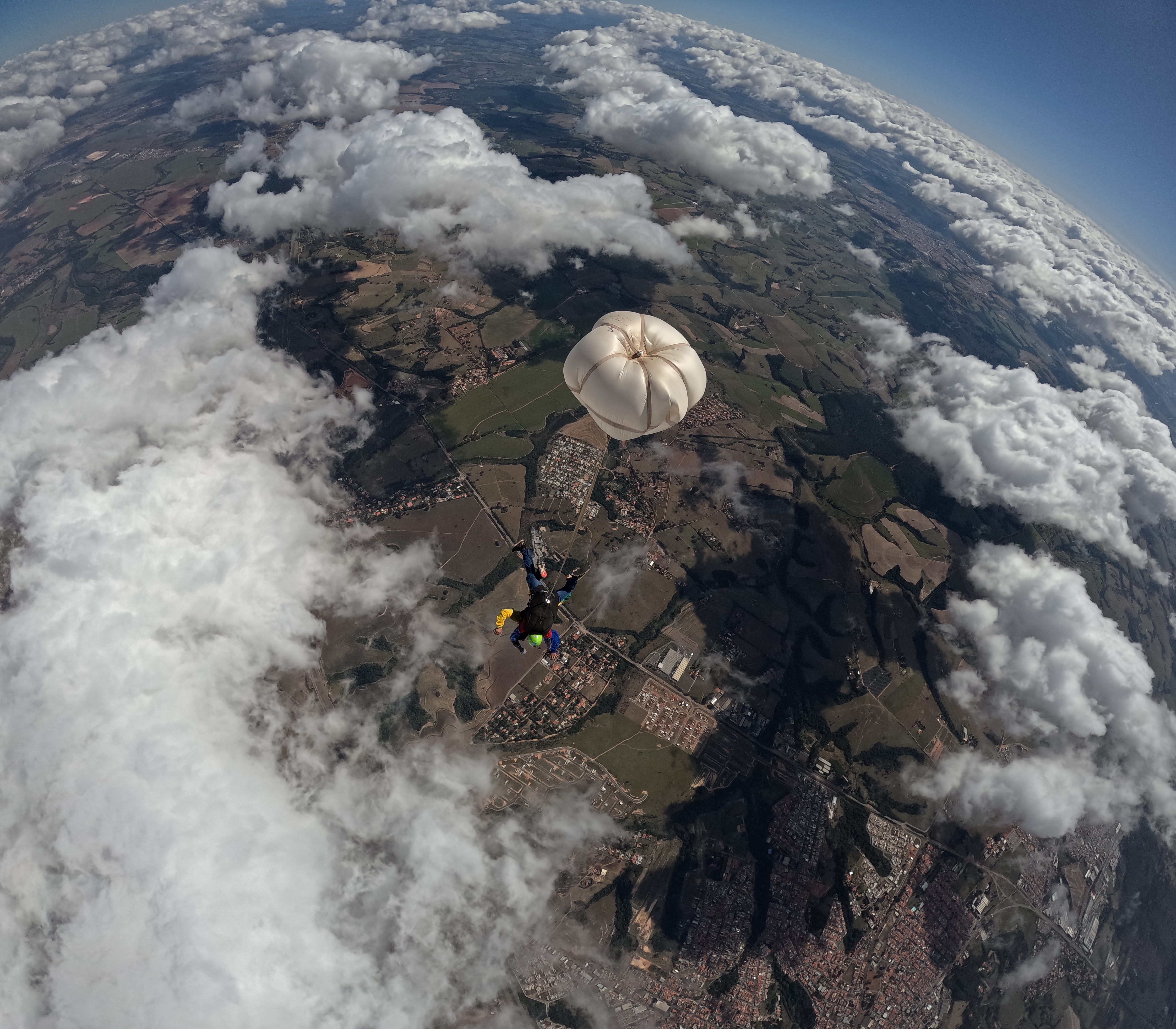 Aerial View of Skydiver with Parachute Over Land · Free Stock Photo