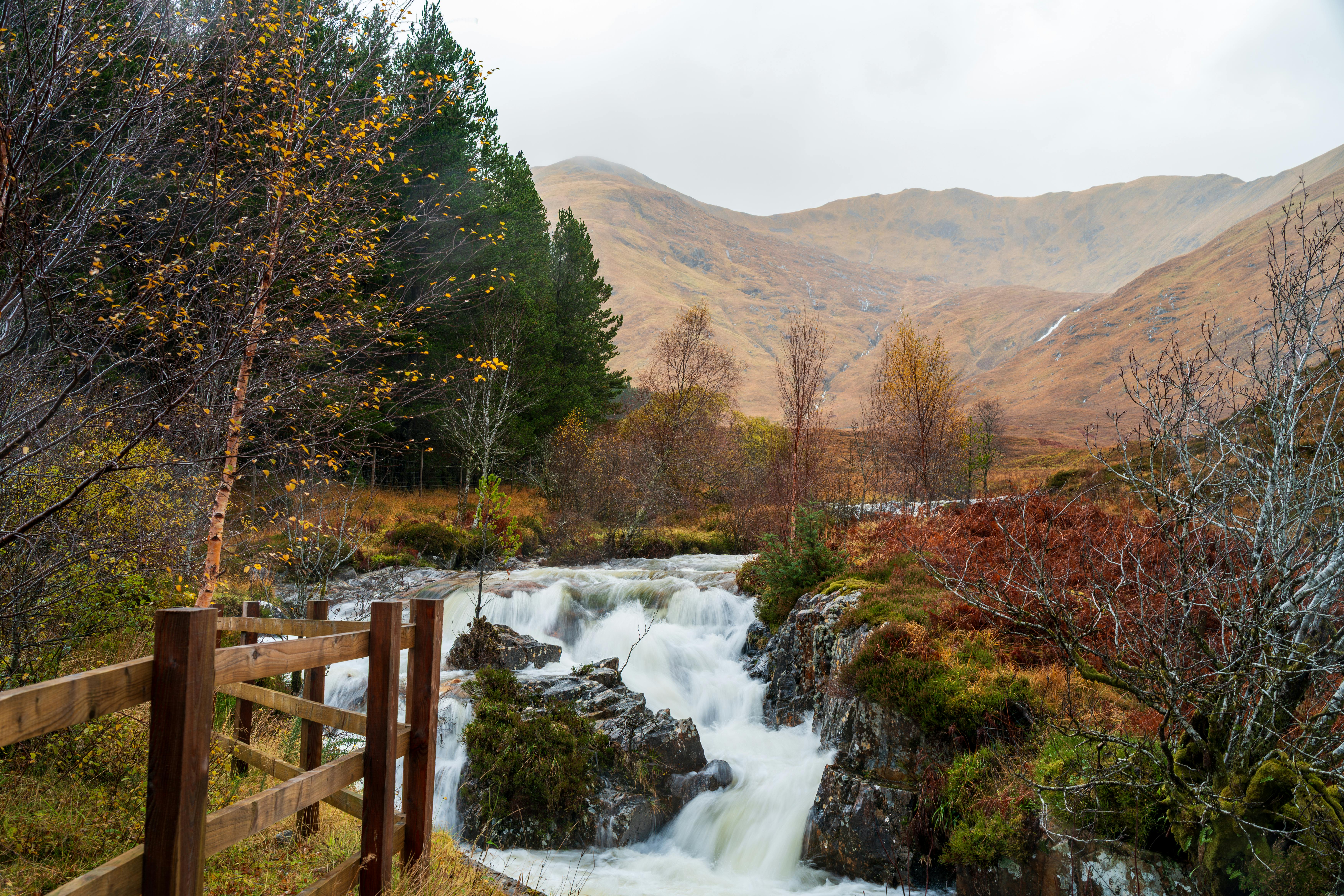 Serene Autumn Waterfall in Scenic Mountain Landscape · Free Stock Photo