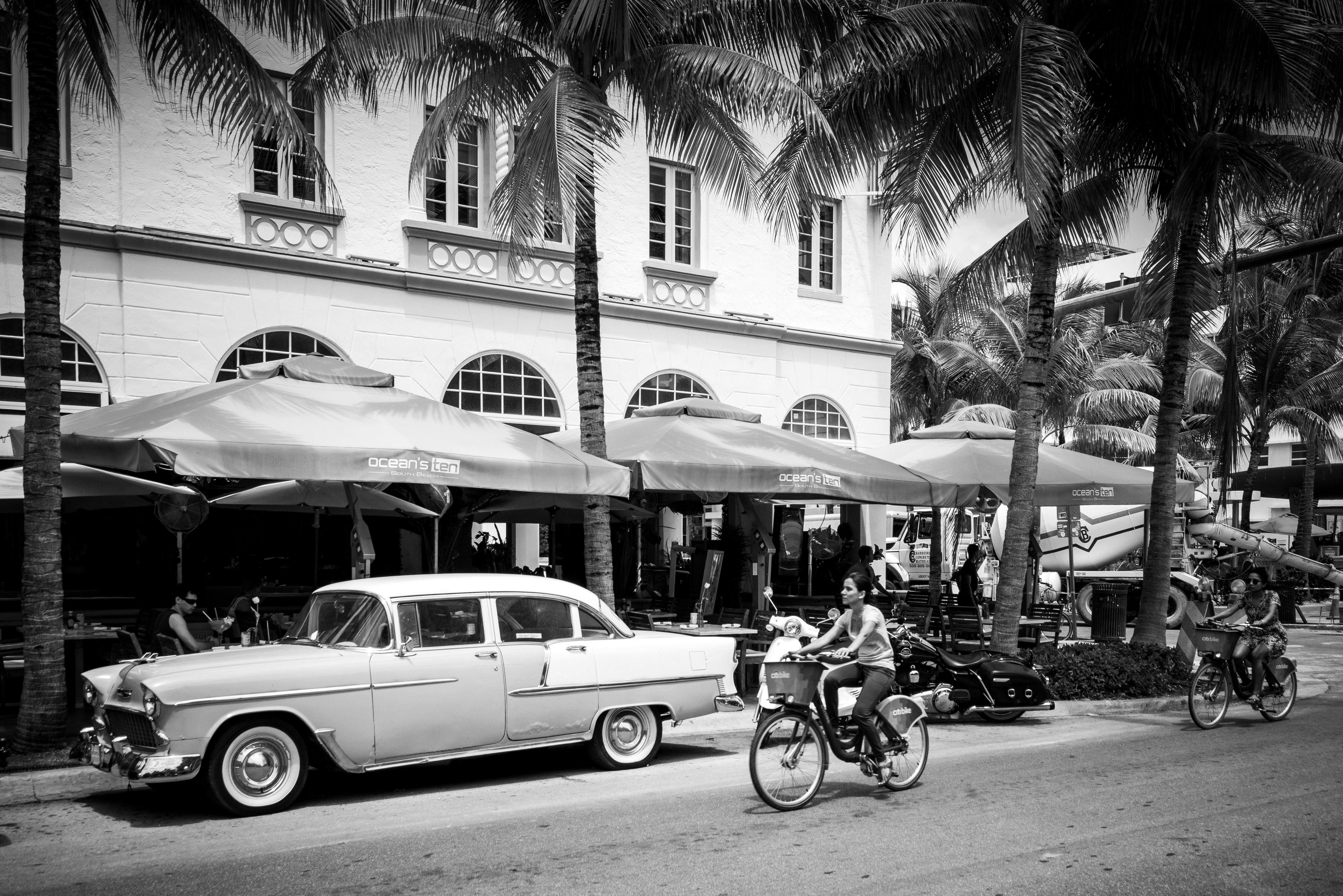 Vintage Car and Bicyclists on Busy Miami Street · Free Stock Photo
