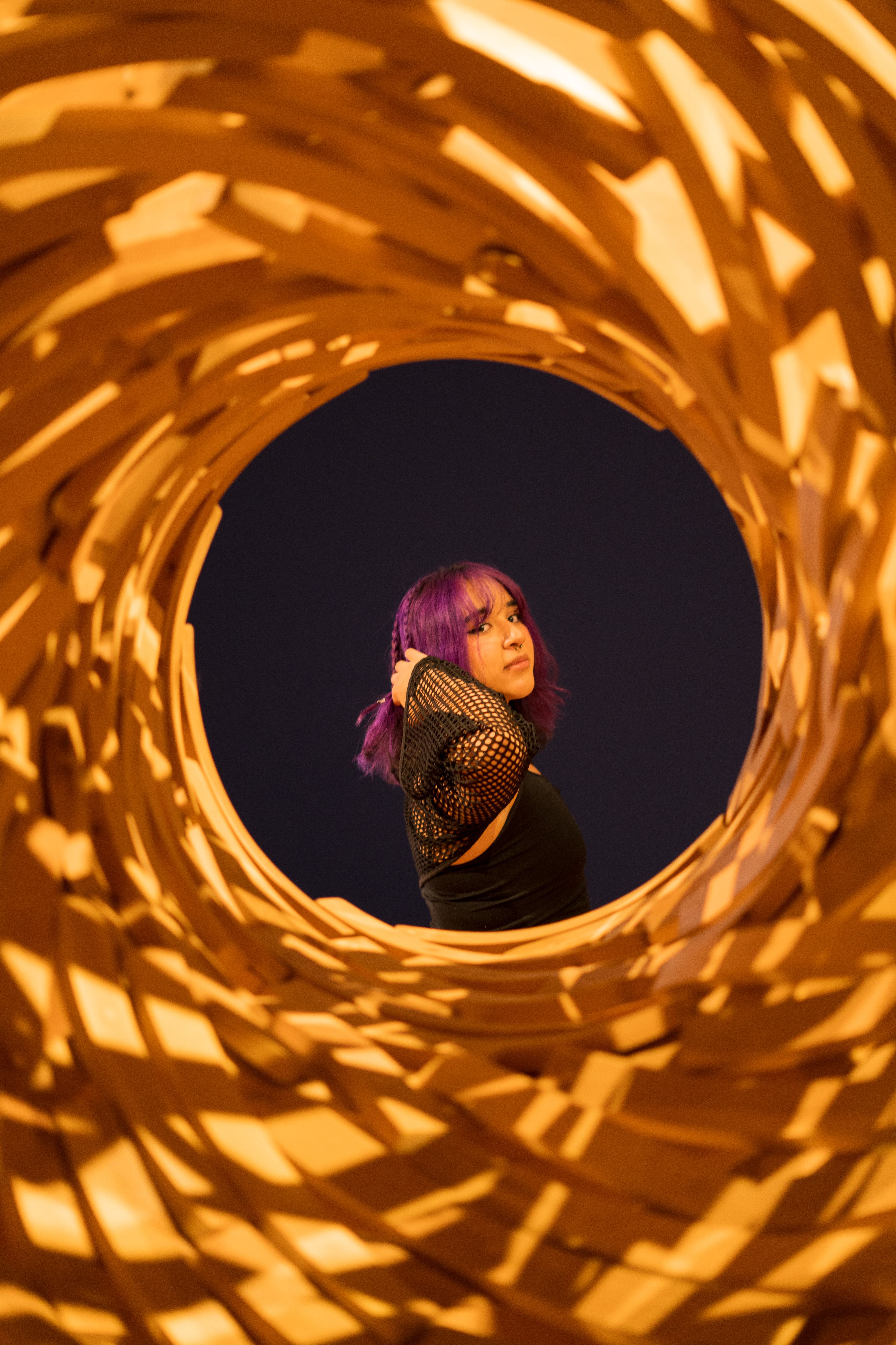 Artistic Portrait through Sculptural Spiral Opening · Free Stock Photo