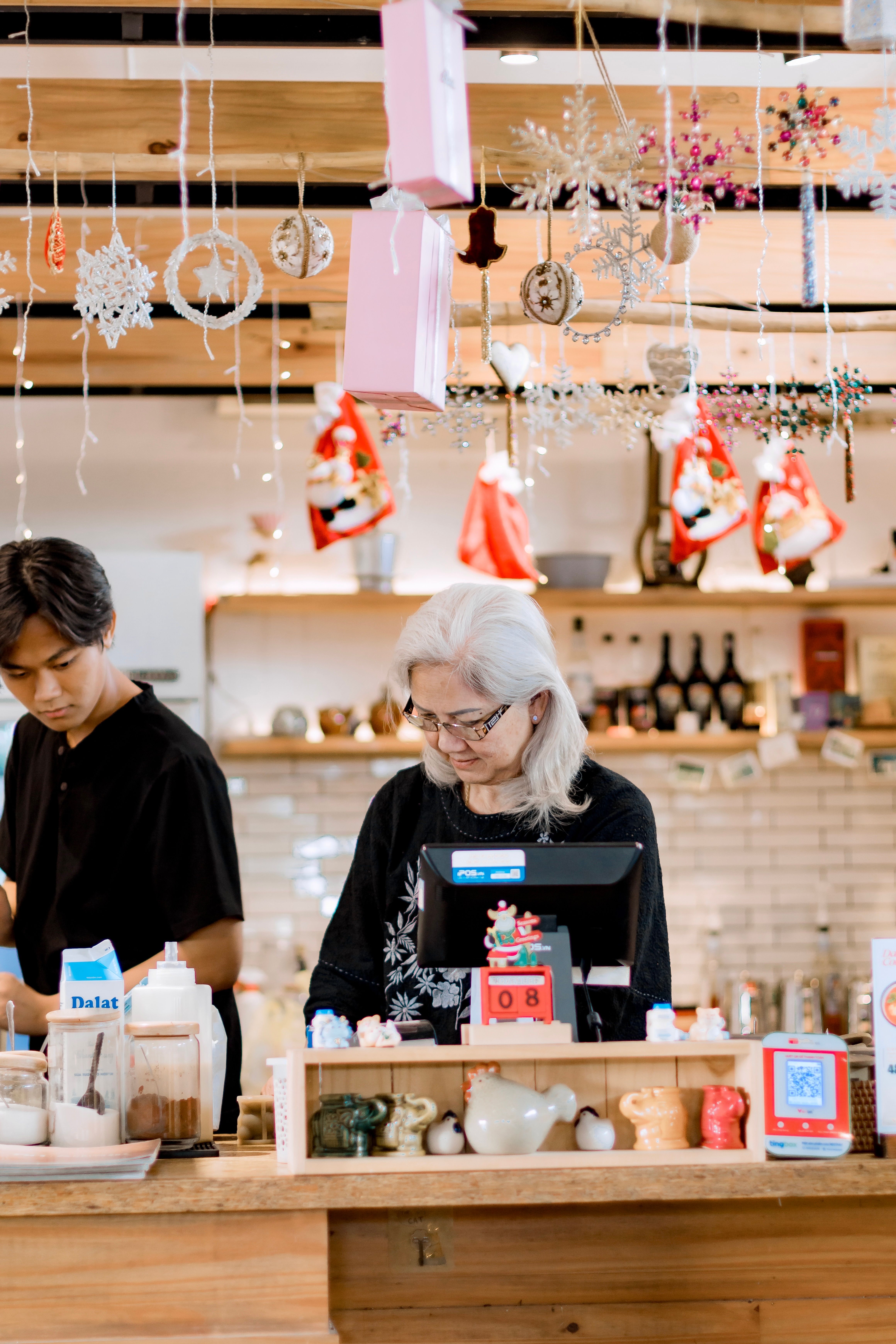 Festive Coffee Shop Scene with Decor and Staff · Free Stock Photo