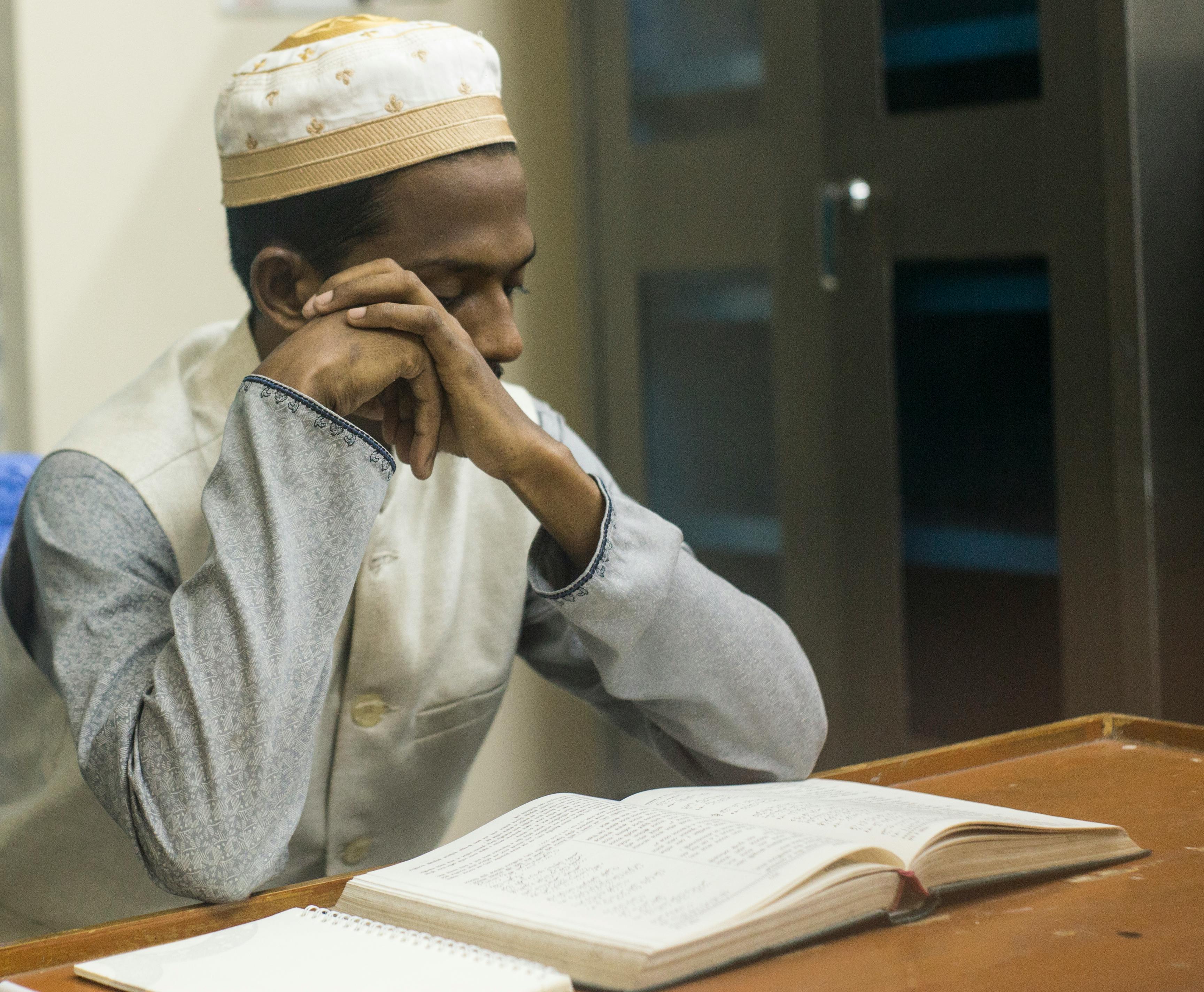 Muslim Man Deep in Study with the Quran · Free Stock Photo
