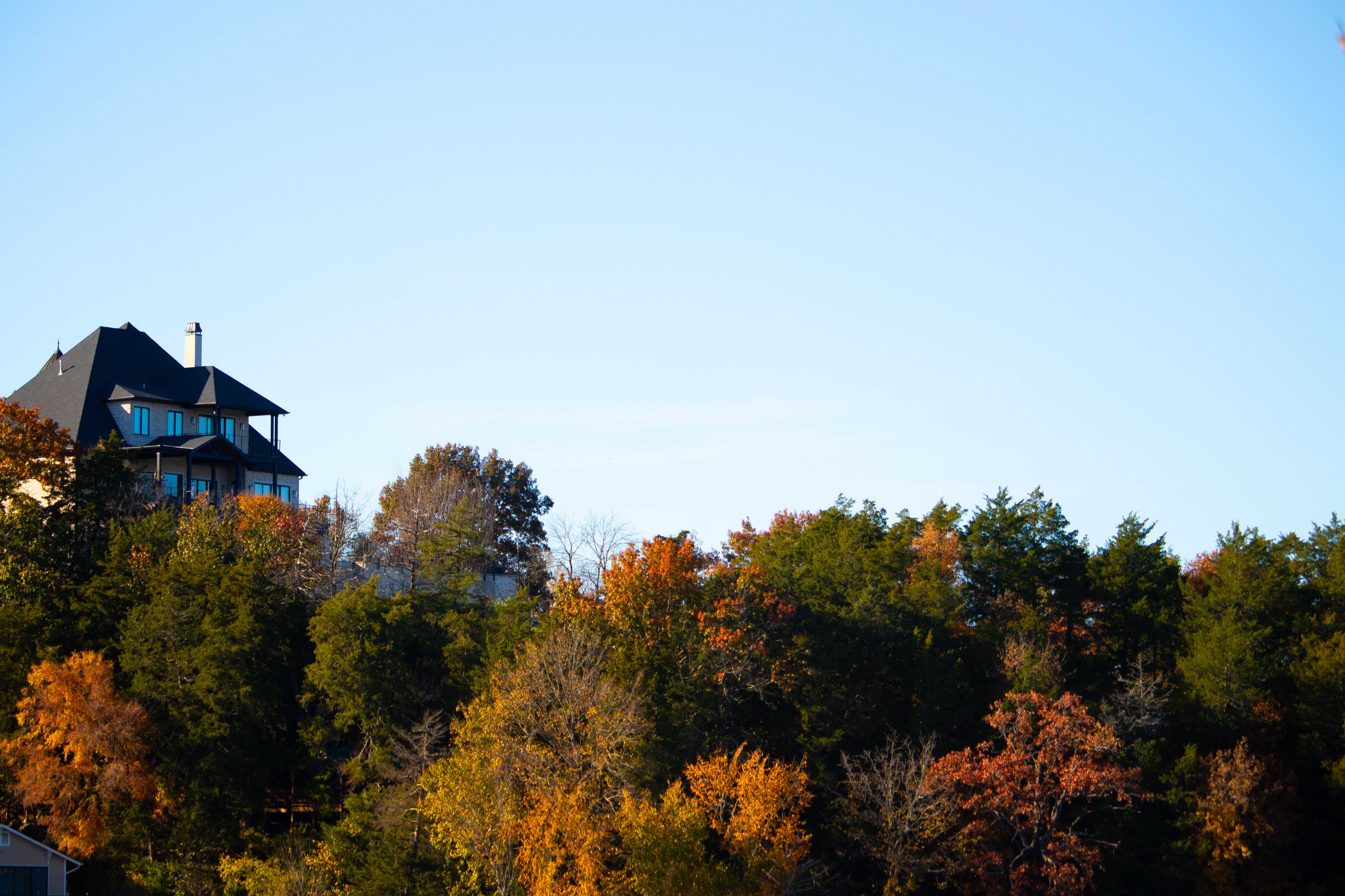 Scenic Hillside Home Surrounded by Fall Foliage · Free Stock Photo