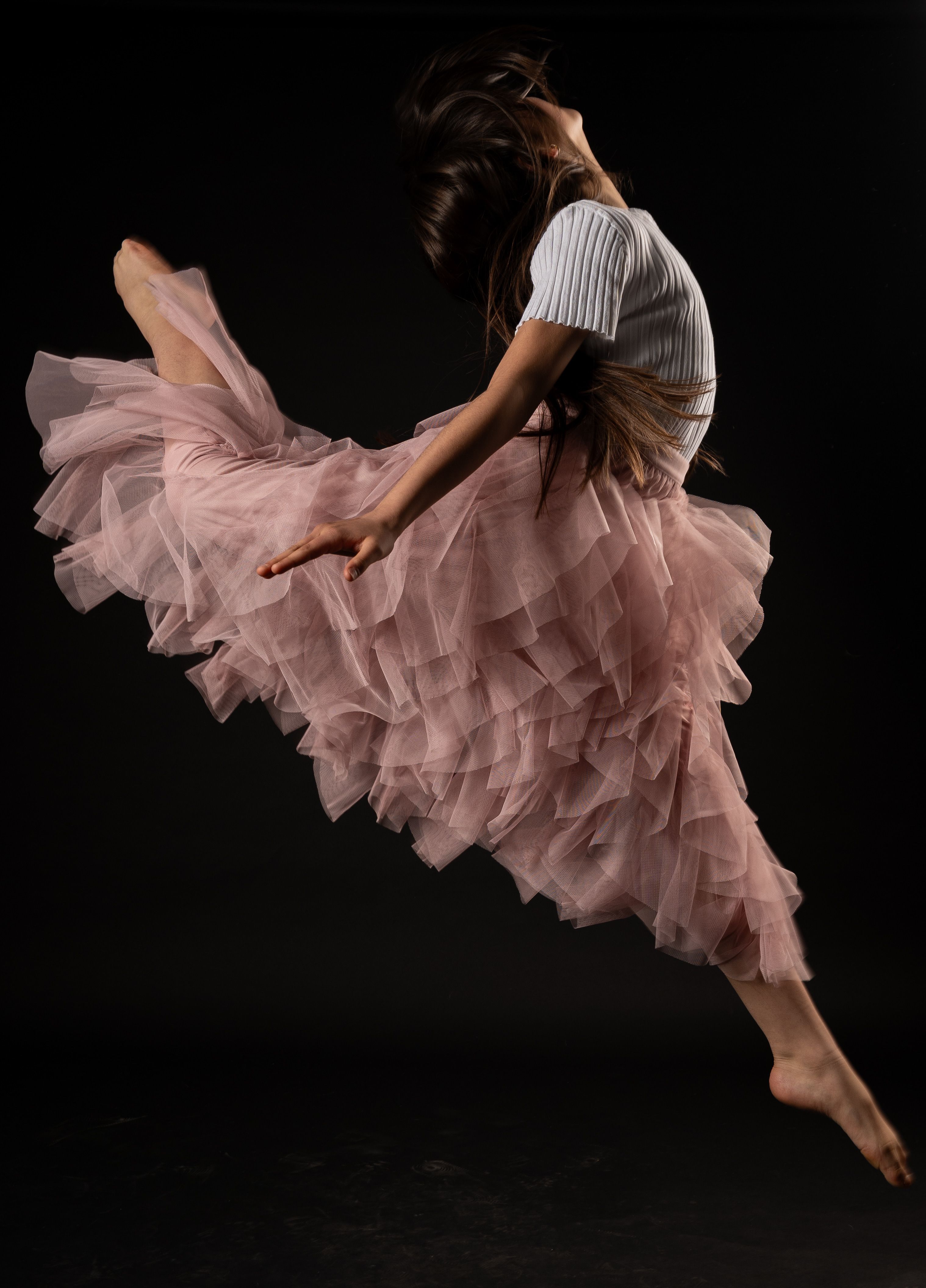 Elegant Ballet Dancer in Motion Against Dark Background · Free Stock Photo