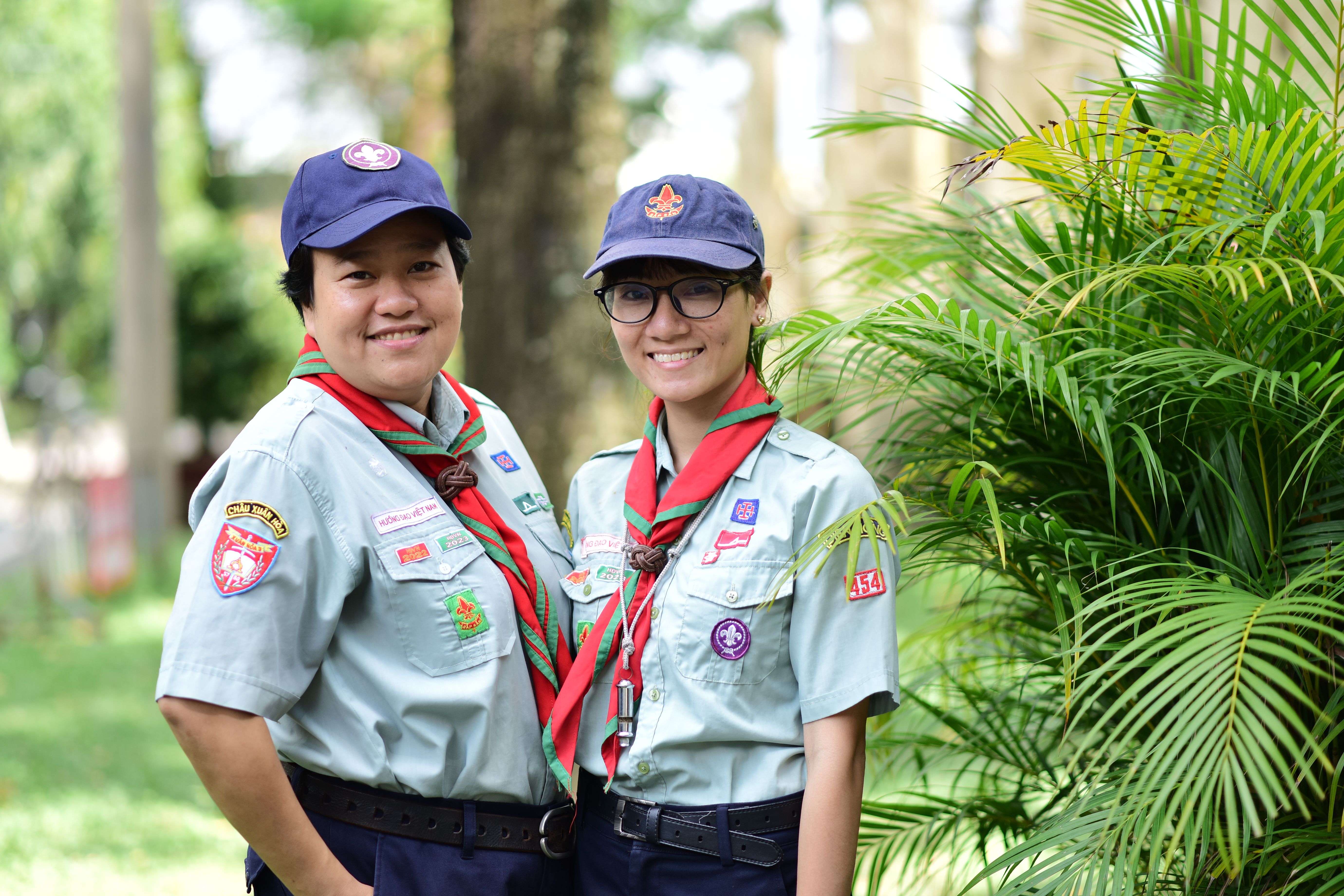 Two Scout Leaders Smiling Outdoors in Uniform · Free Stock Photo