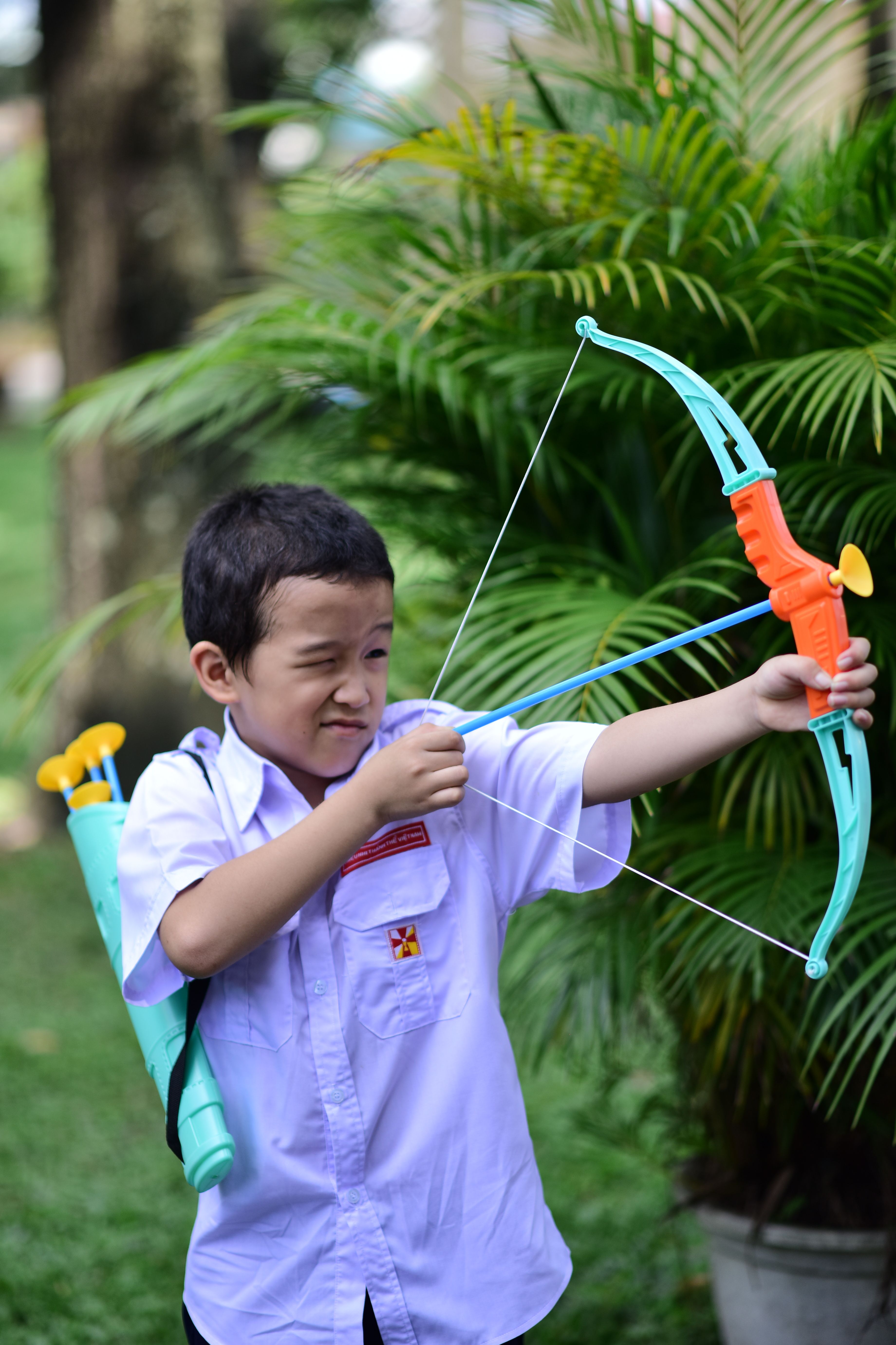 Young Boy Plays Outdoors with Toy Bow and Arrow · Free Stock Photo