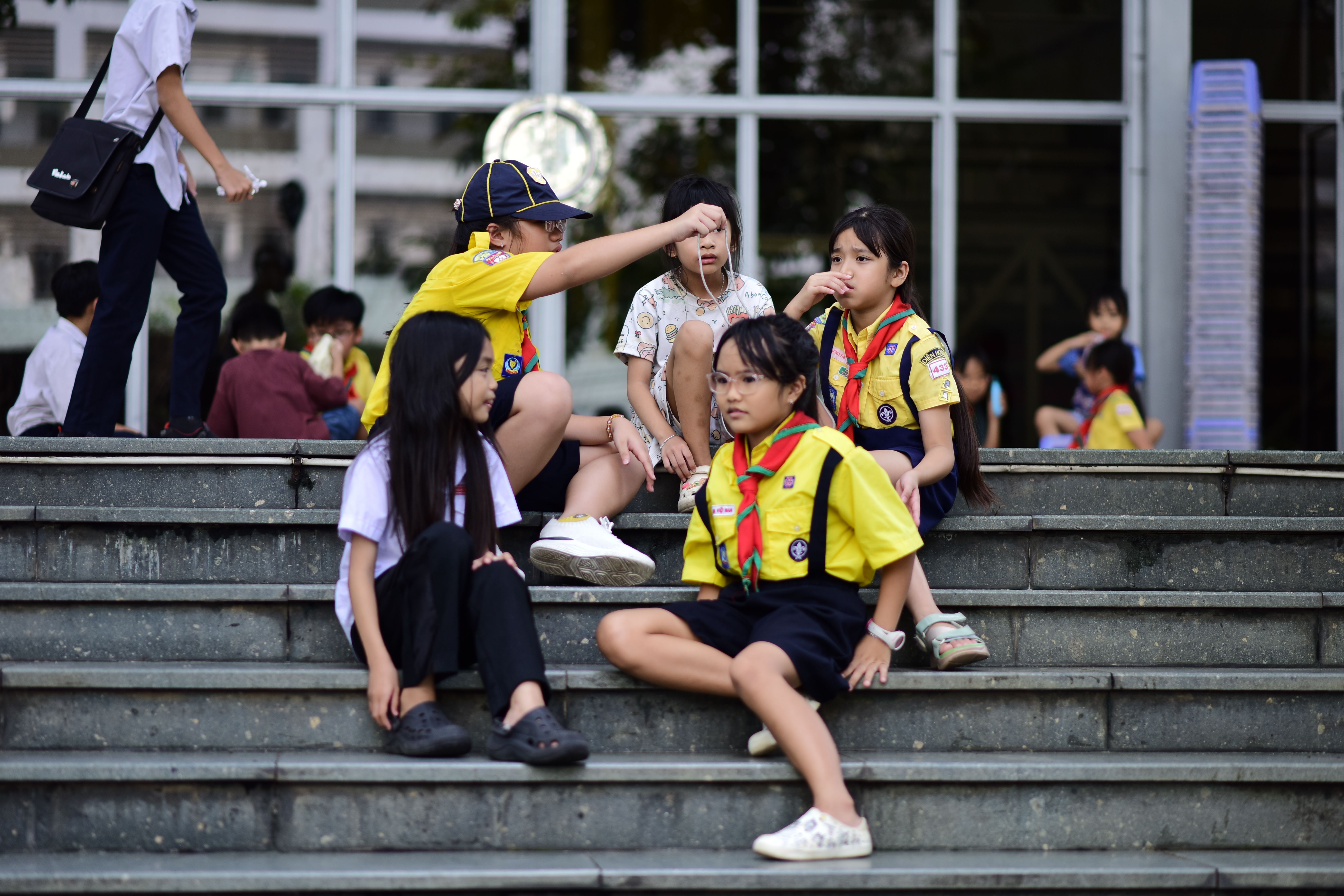Children in Scout Uniform Sitting on Steps Outdoors · Free Stock Photo