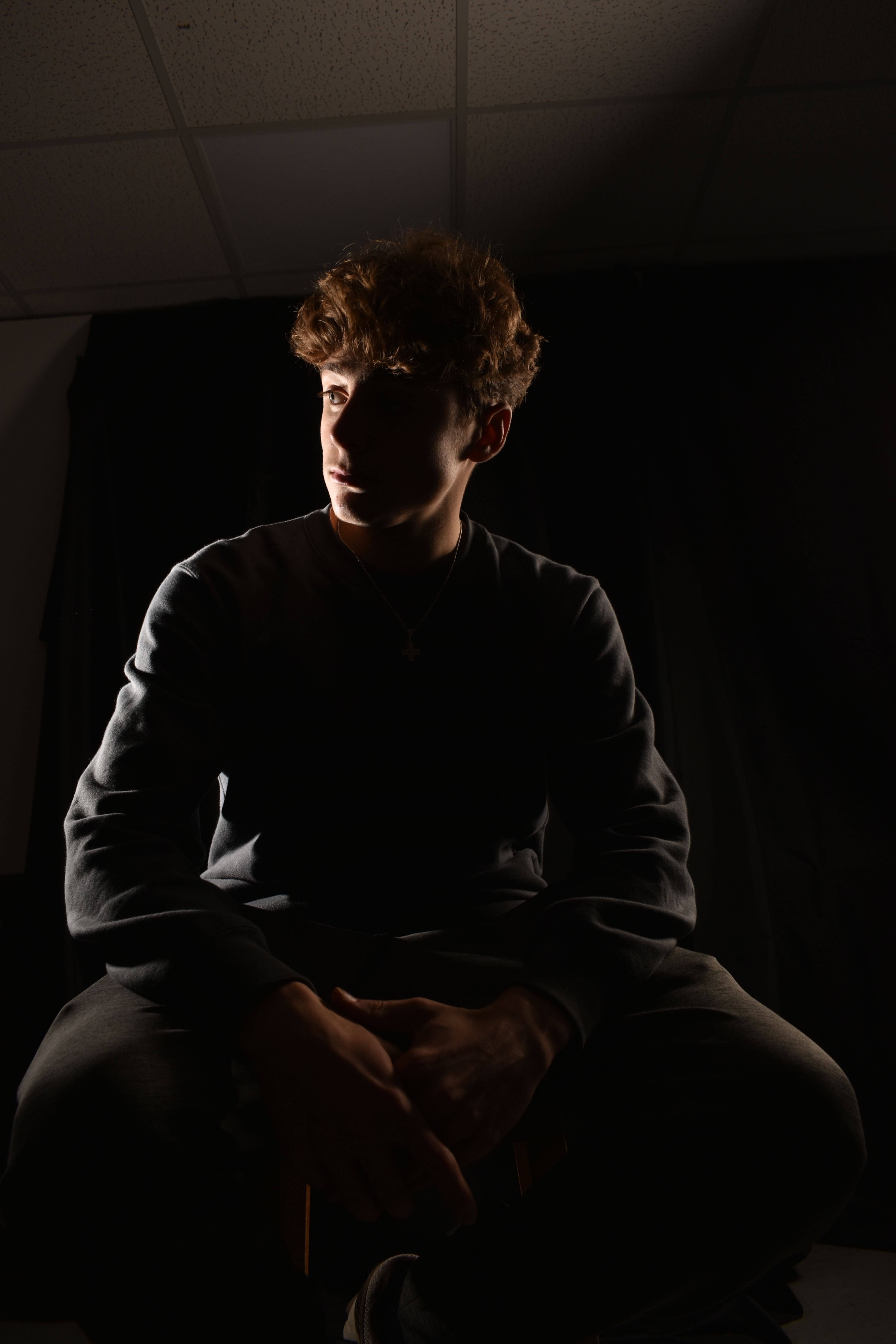 Moody Portrait of a Young Man in Dramatic Lighting · Free Stock Photo