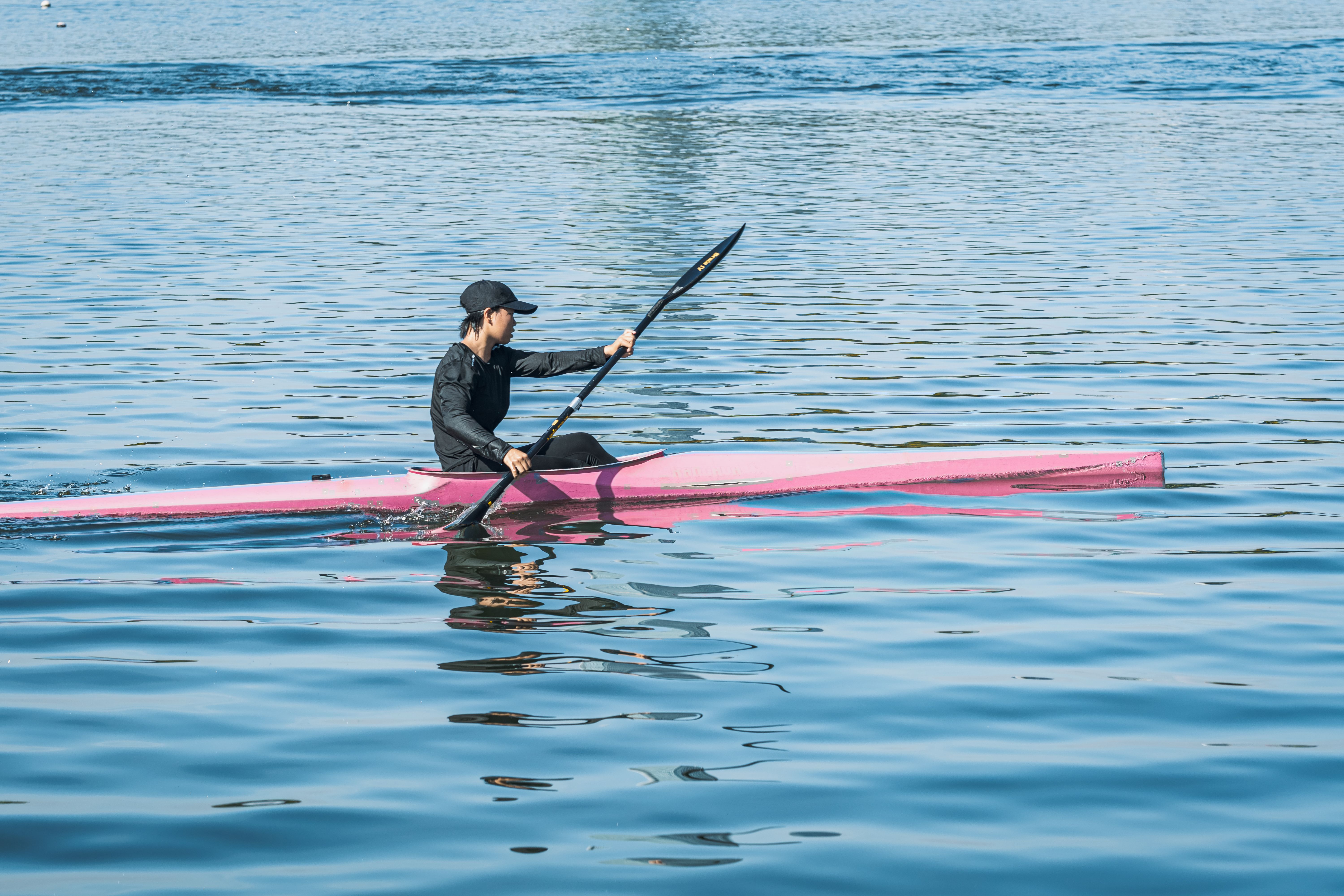 Person Kayaking on Calm Water in Pink Kayak · Free Stock Photo