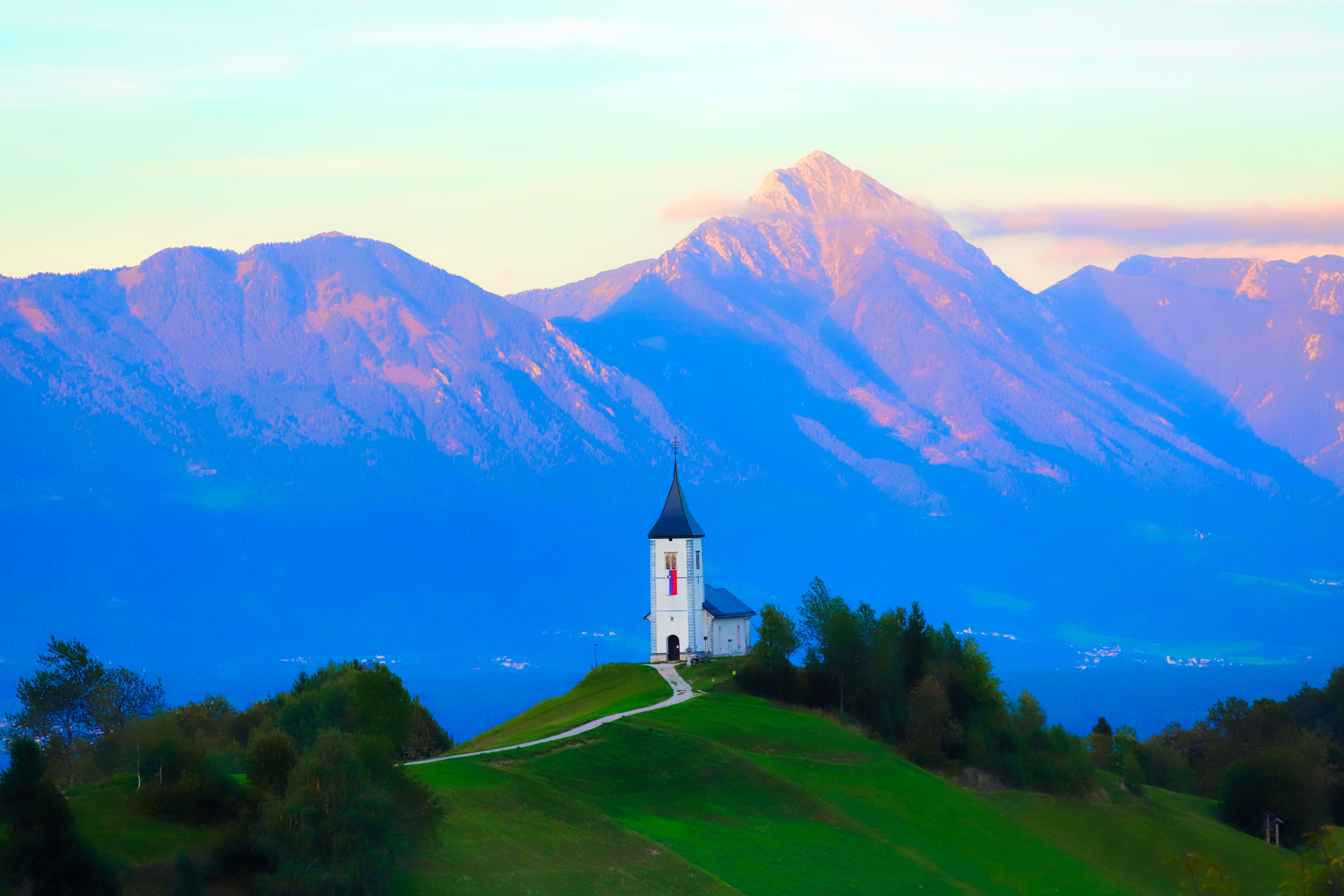 Picturesque Alpine Church and Mountains at Sunrise · Free Stock Photo