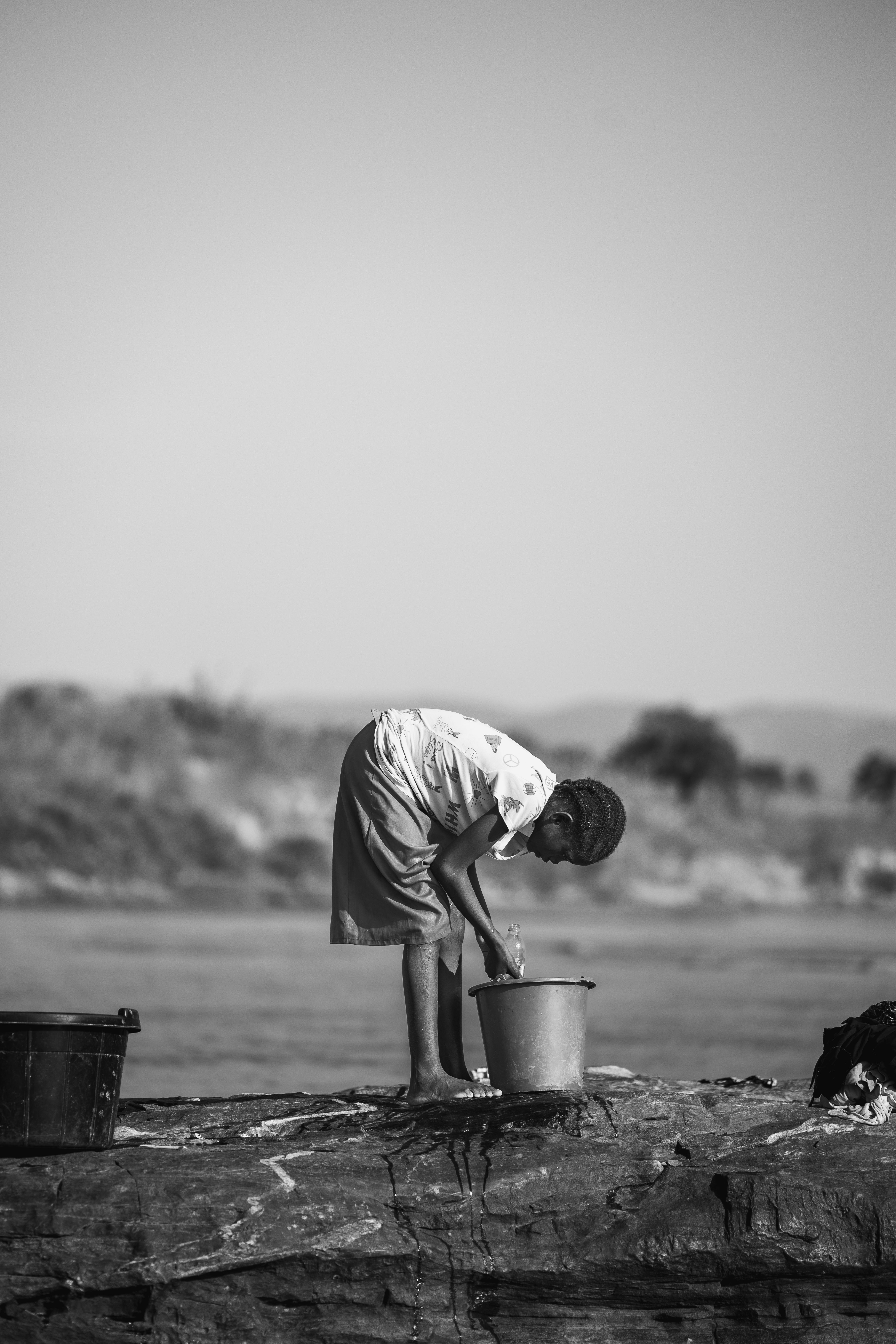 African Girl Washing by the River in Nigeria · Free Stock Photo