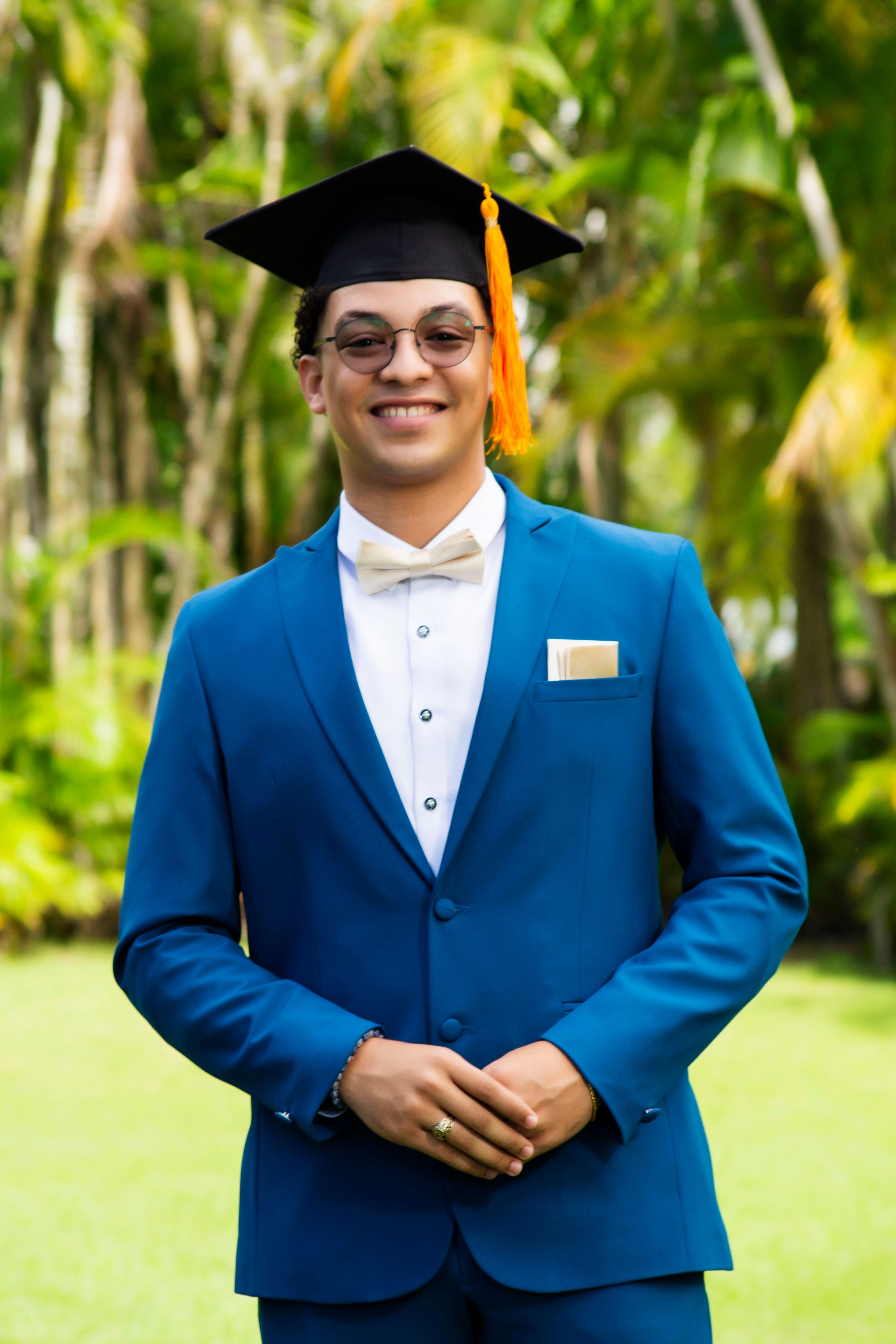 Young Graduate Smiling in Cap and Gown Outdoors · Free Stock Photo
