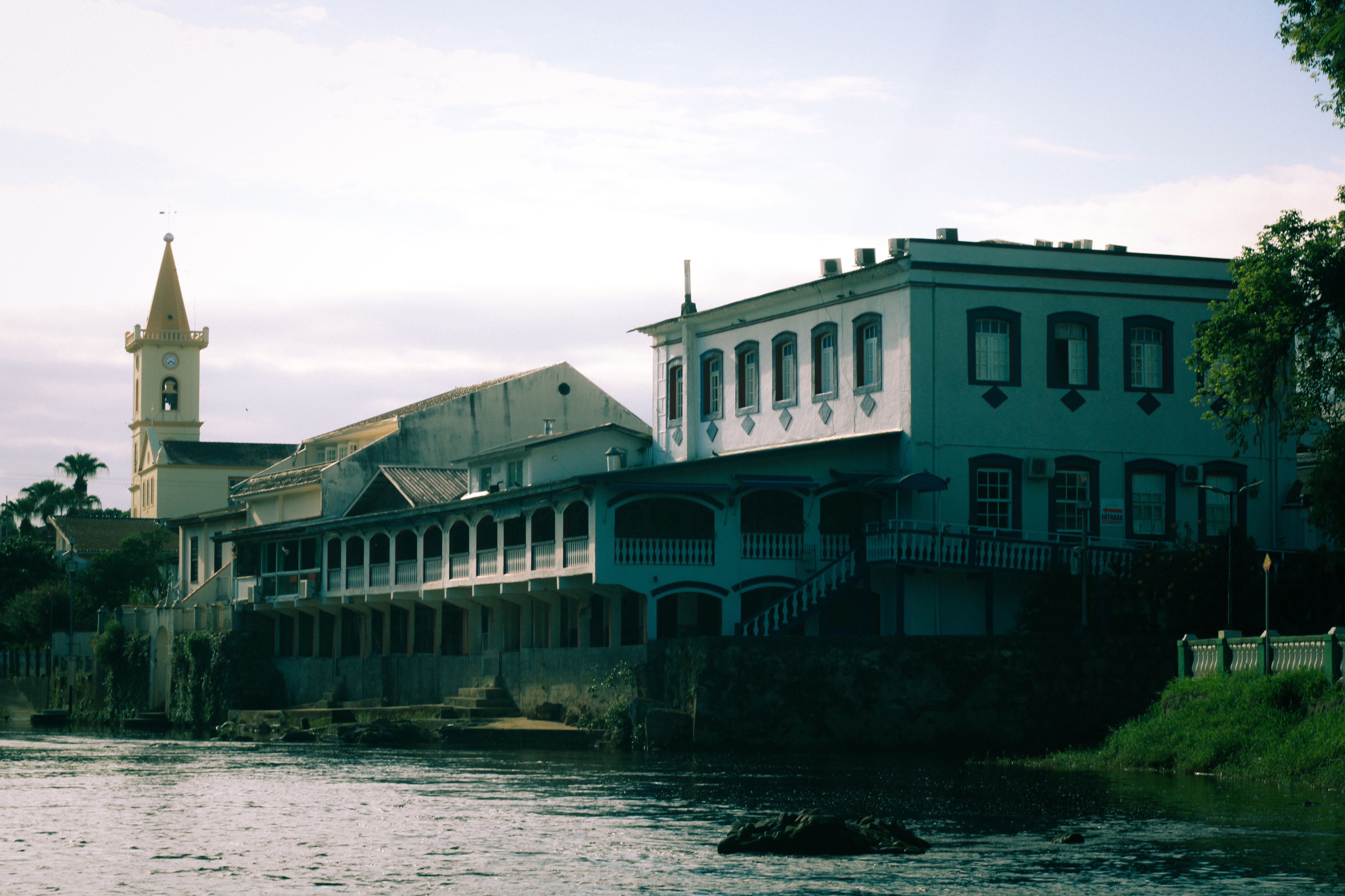 Historic Riverside Architecture with Bell Tower · Free Stock Photo