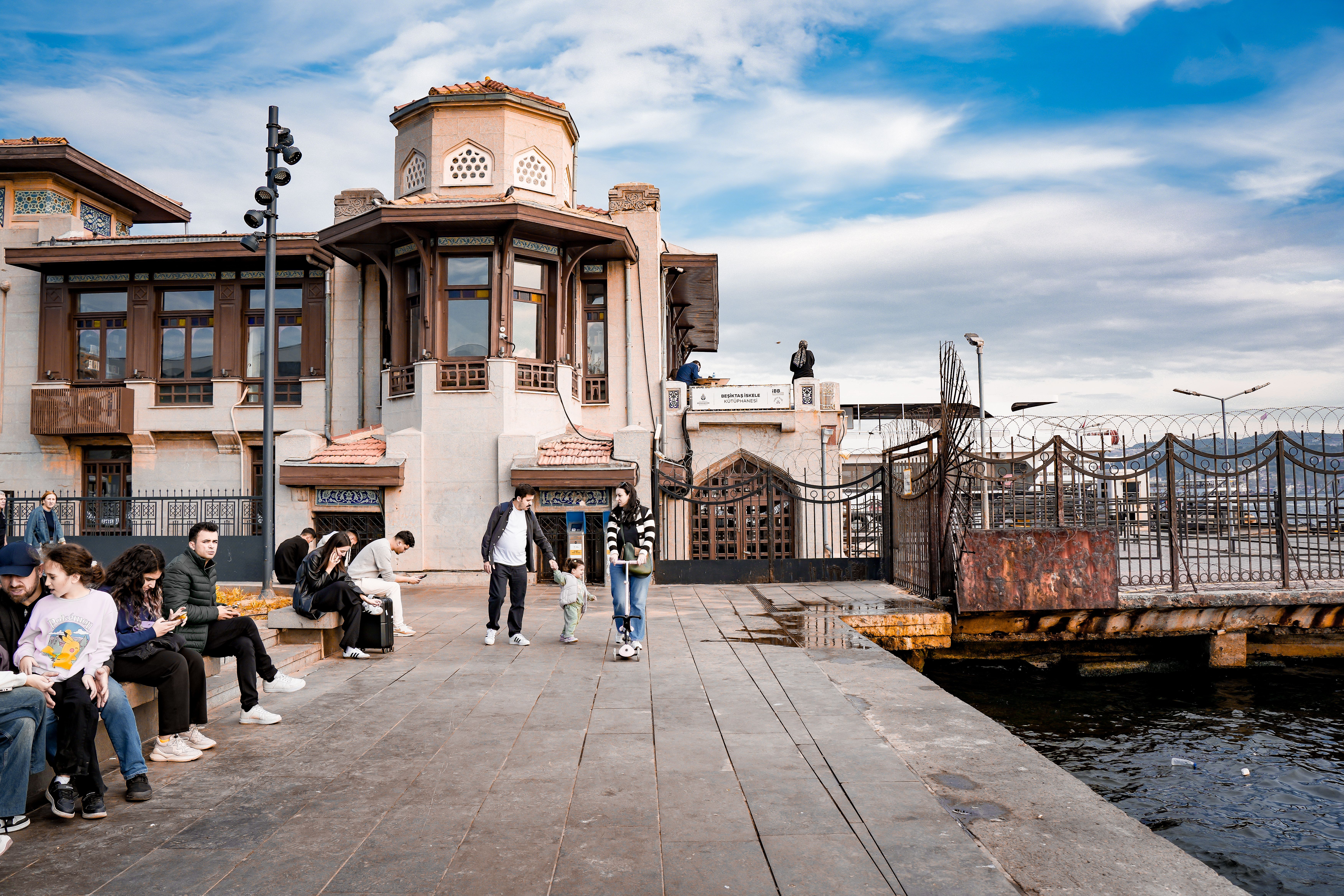 Scenic Waterfront Promenade with Historic Architecture · Free Stock Photo