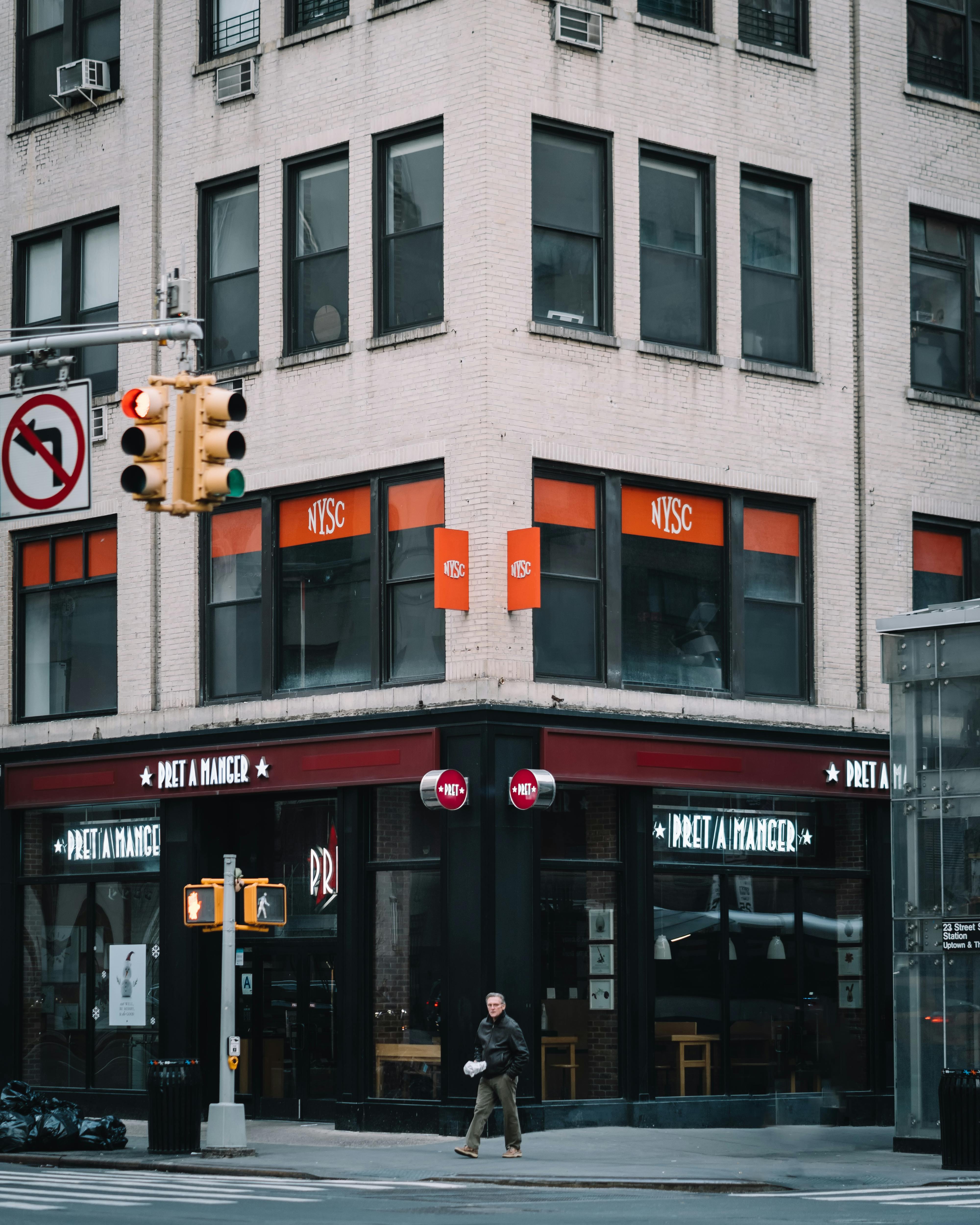 Man Walking Beside Building · Free Stock Photo