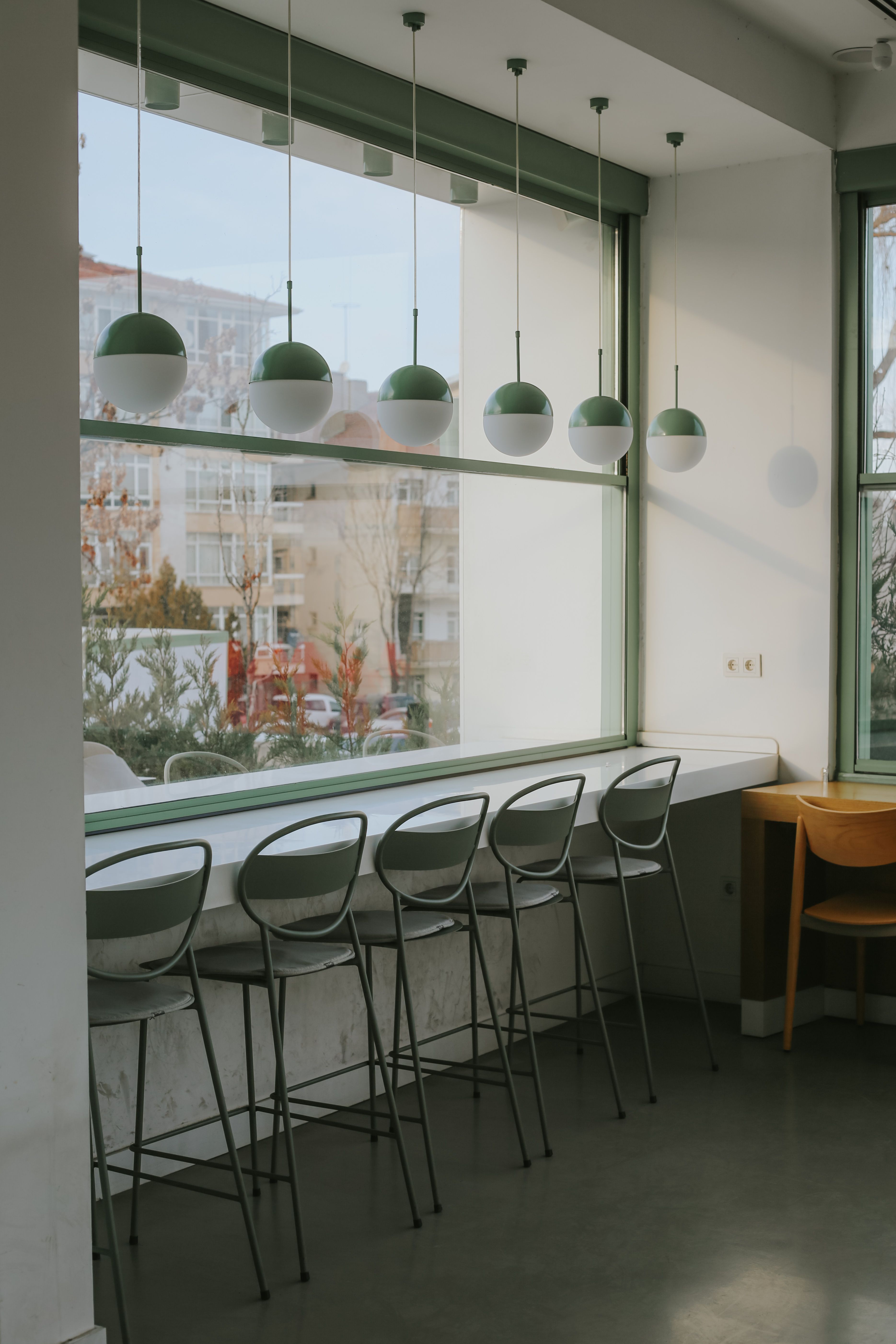 Cozy Indoor Cafe Seating with Large Windows · Free Stock Photo