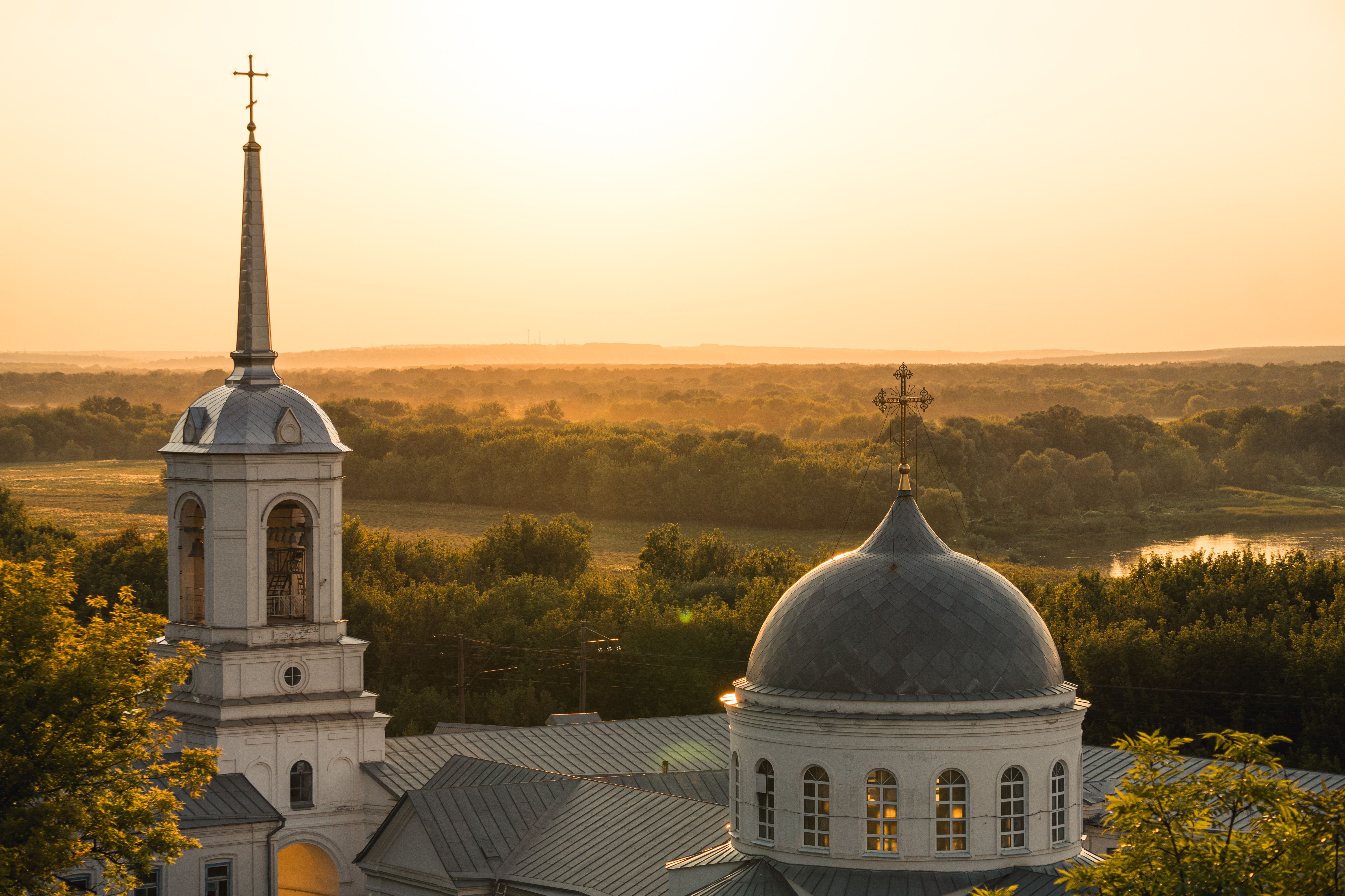 Scenic Sunset Over Historic Church and Landscape · Free Stock Photo
