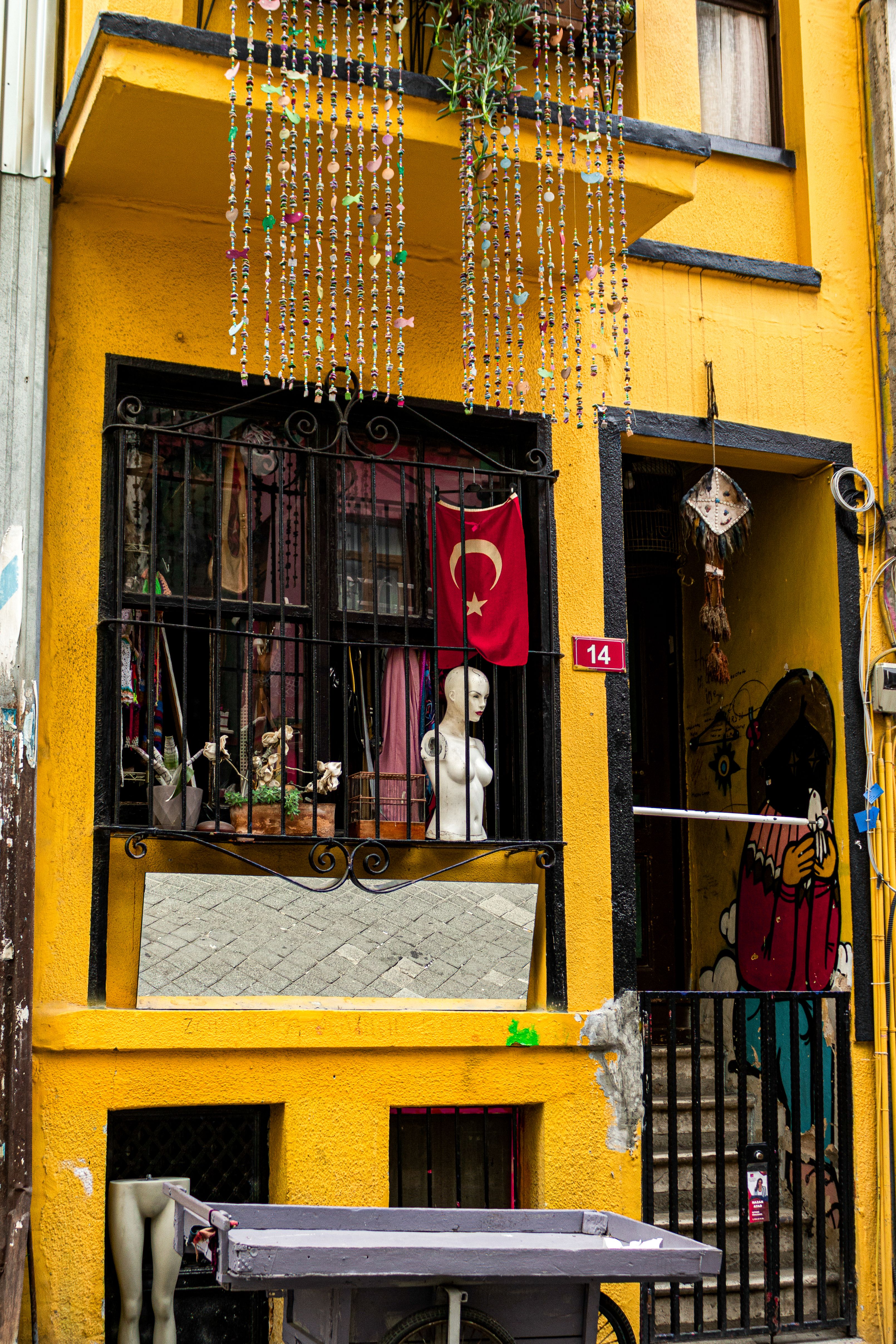 Vibrant Yellow Storefront with Turkish Flag · Free Stock Photo