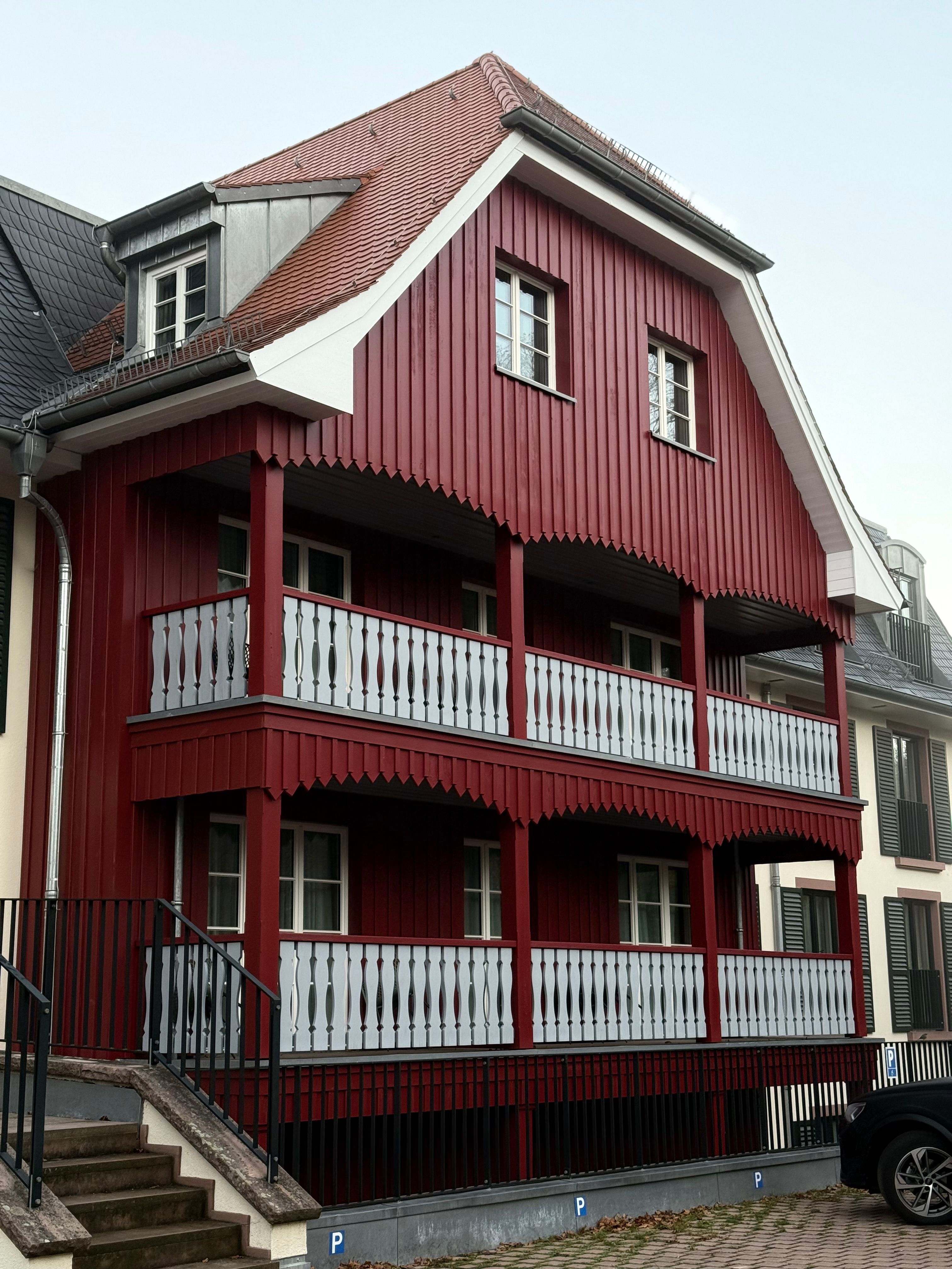 Charming Red Wooden Building with Balconies · Free Stock Photo