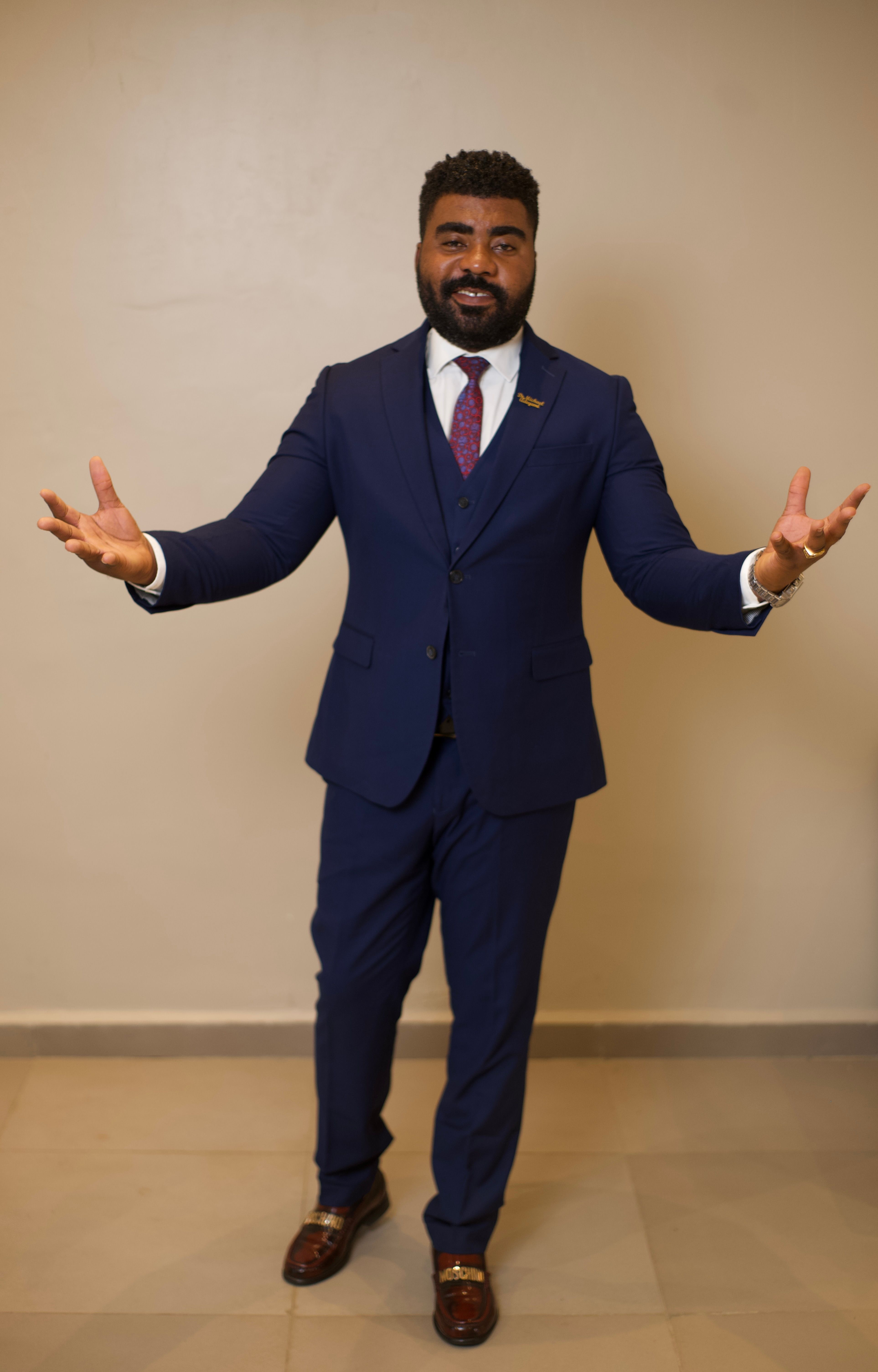 Confident Businessman in Navy Suit with Open Arms · Free Stock Photo