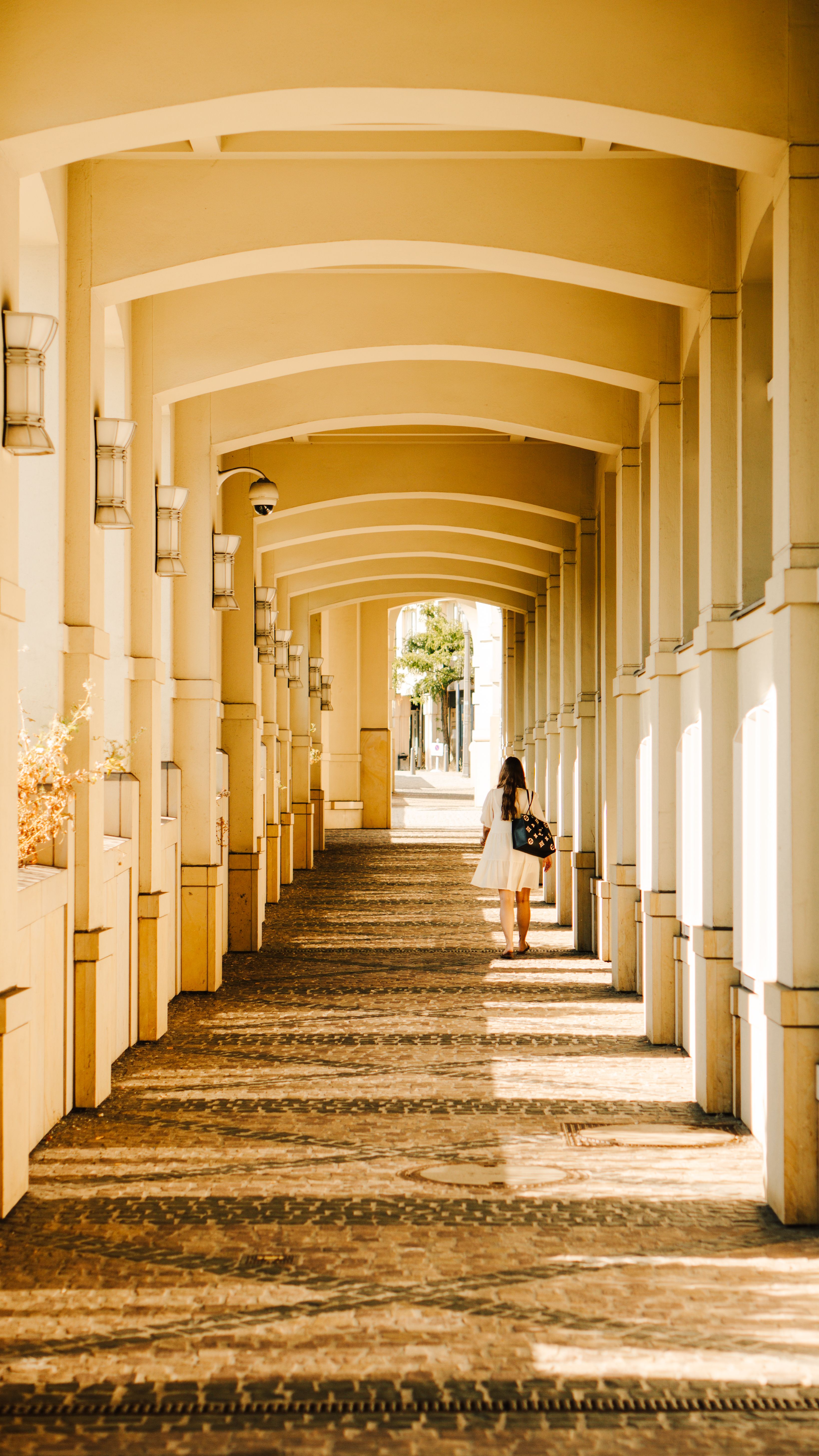 Elegant Arcade Walkway with Single Female · Free Stock Photo