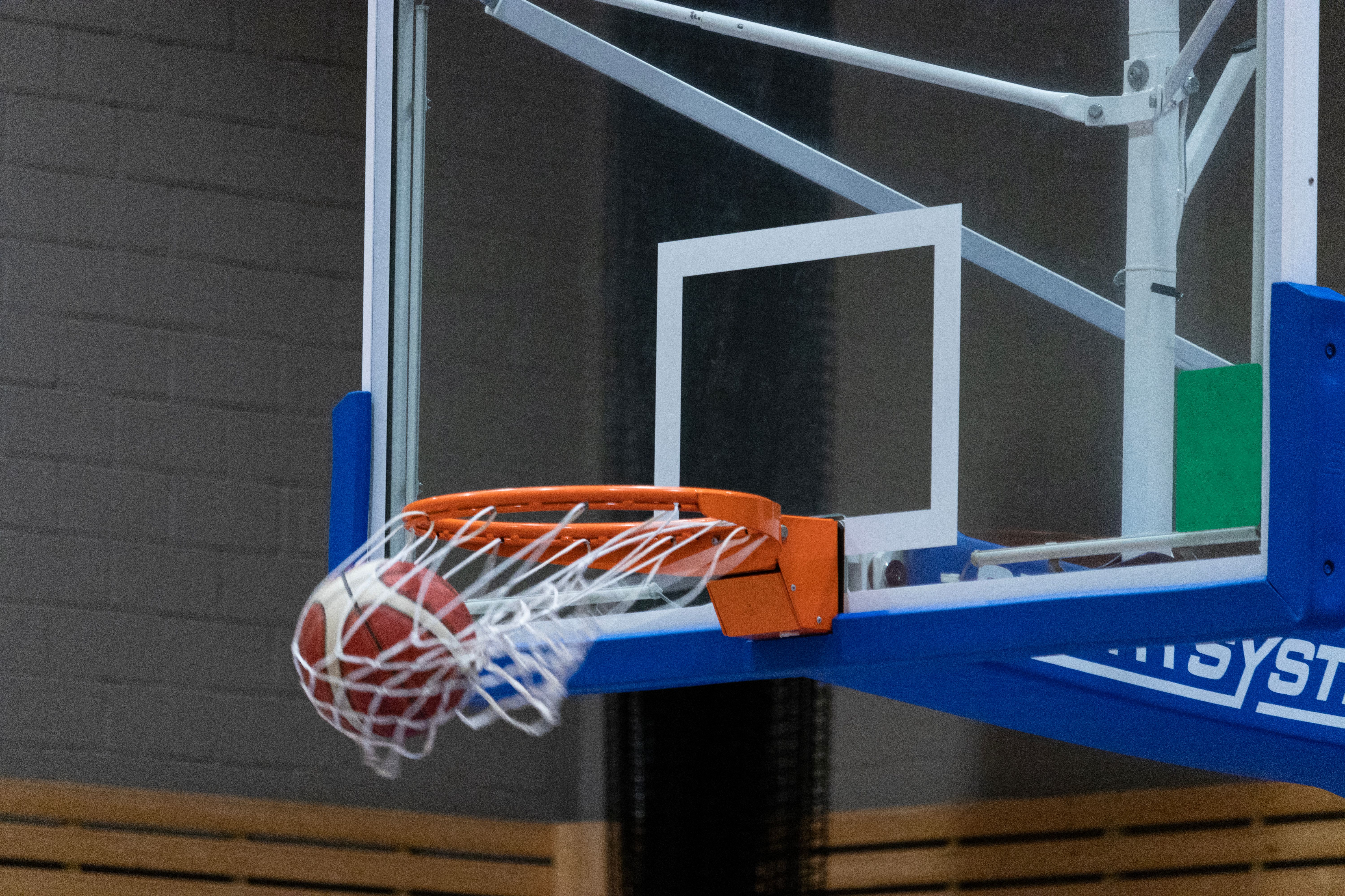 Basketball Going Through Hoop on Indoor Court · Free Stock Photo